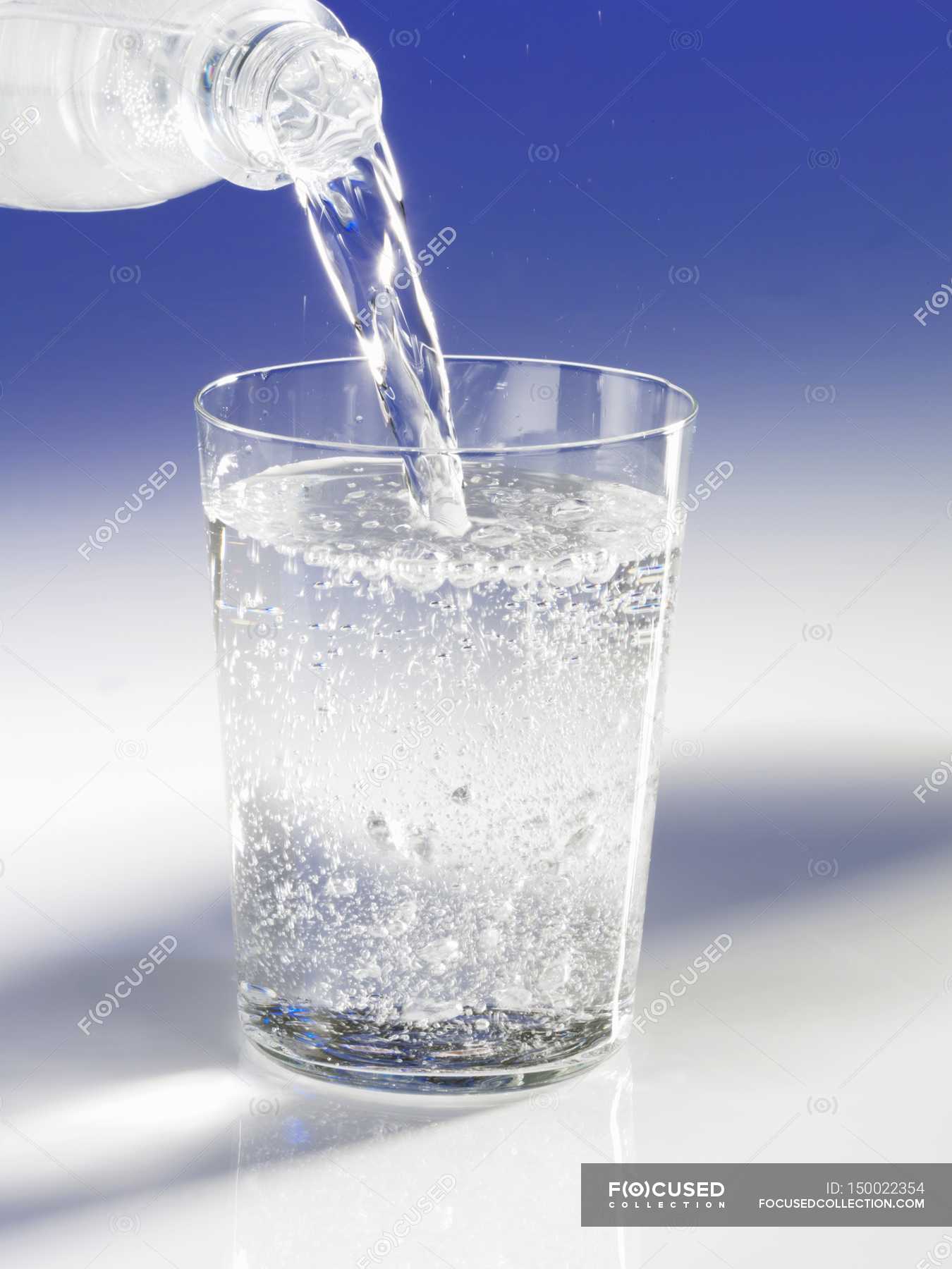 Pouring mineral water — non alcoholic, being poured in - Stock Photo | #150022354