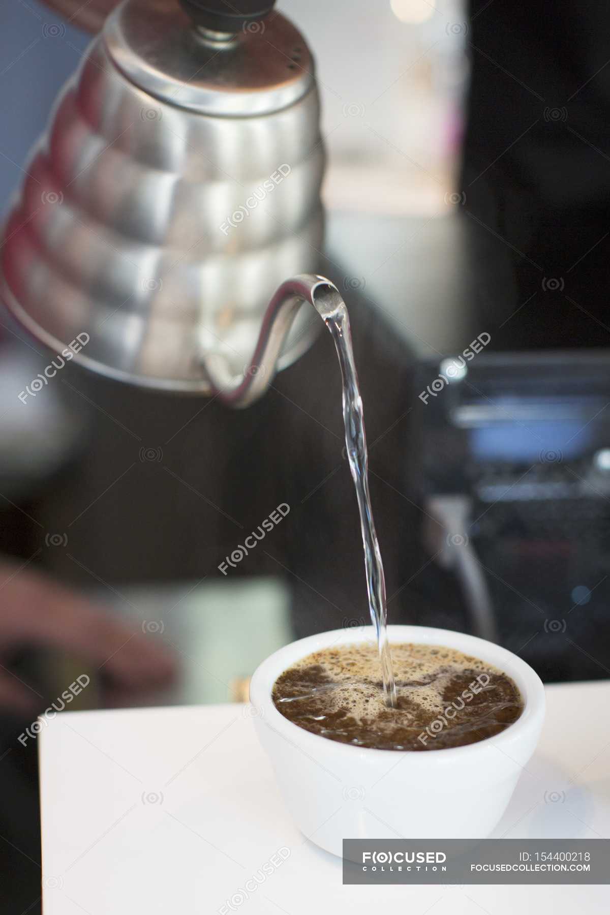 Closeup View Of Pouring Water To Cup Of Coffee Beans Taste Color closeup-view-of-pouring-water-to-cup-of-coffee-beans-taste-color
