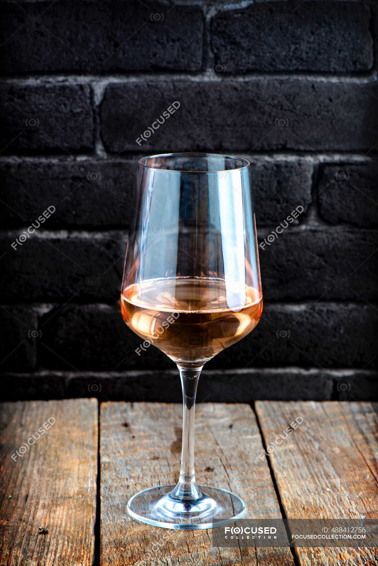 A Single Glass Of Rose Wine On A Rustic Wood With Black Brick Background — Wooden Background