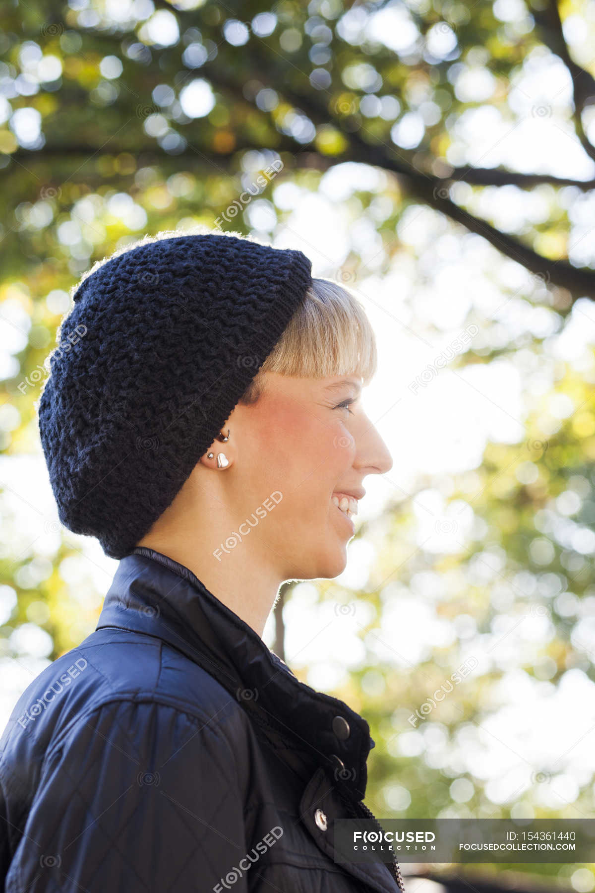 Happy woman wearing knit hat — outdoors, young adult - Stock Photo ...