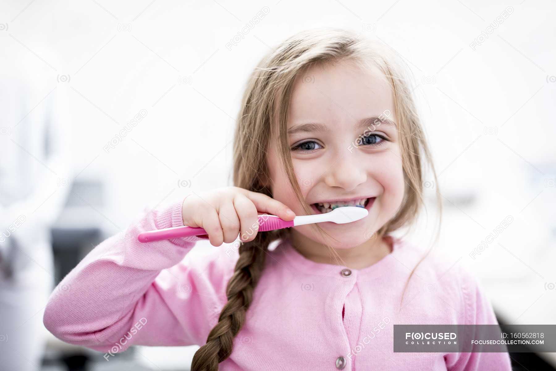 Portrait of little girl brushing teeth. — hygiene, indoor scene - Stock ...