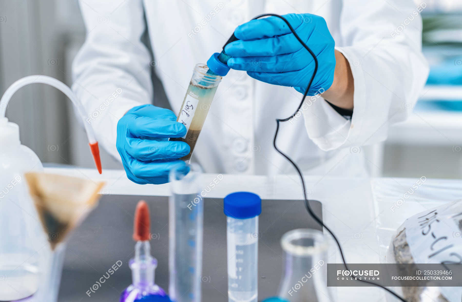 Hands of scientist in laboratory measuring pH of soil samples by ...