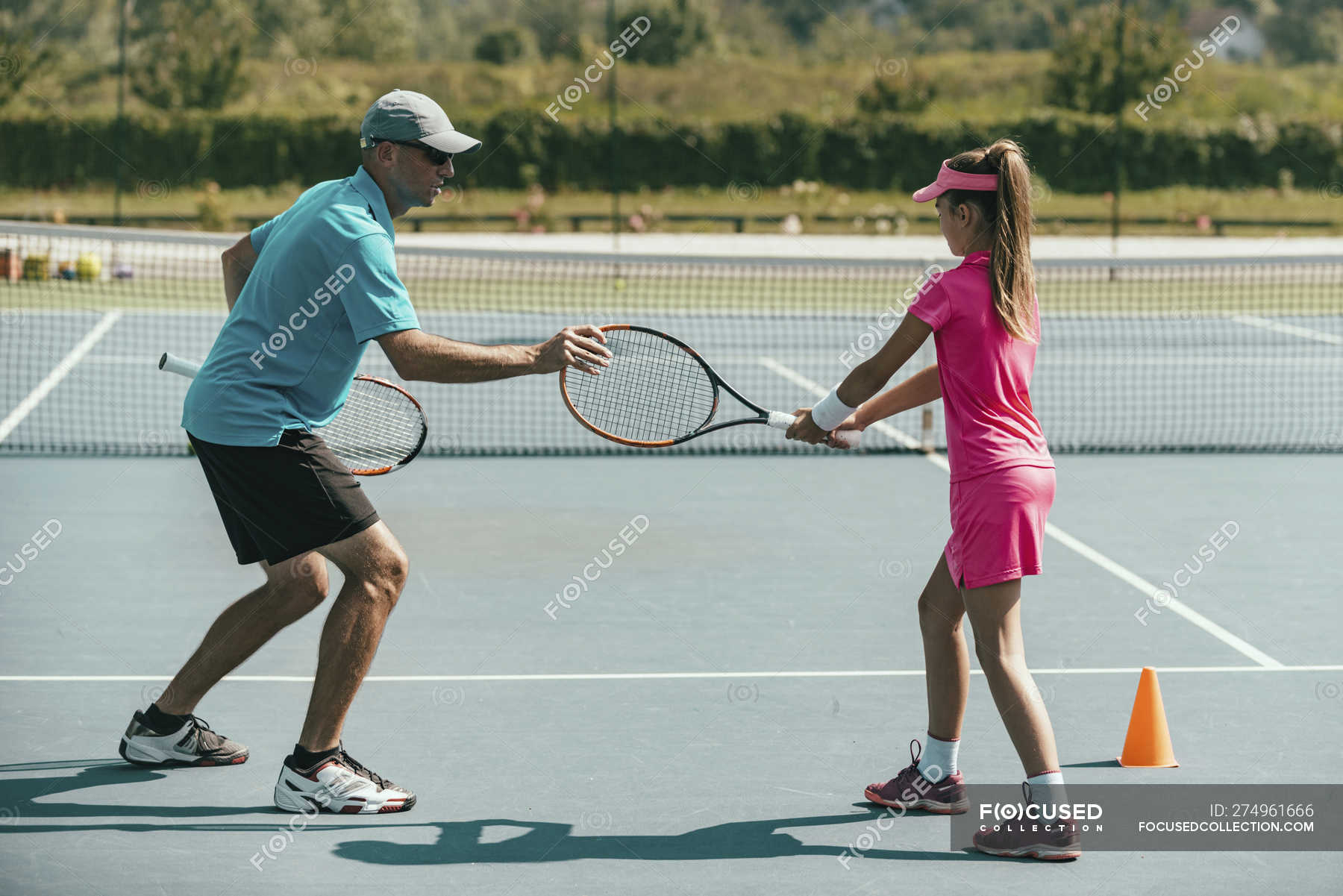 Tennis Instructor Training Teenage Girl On Tennis Court — Racquets