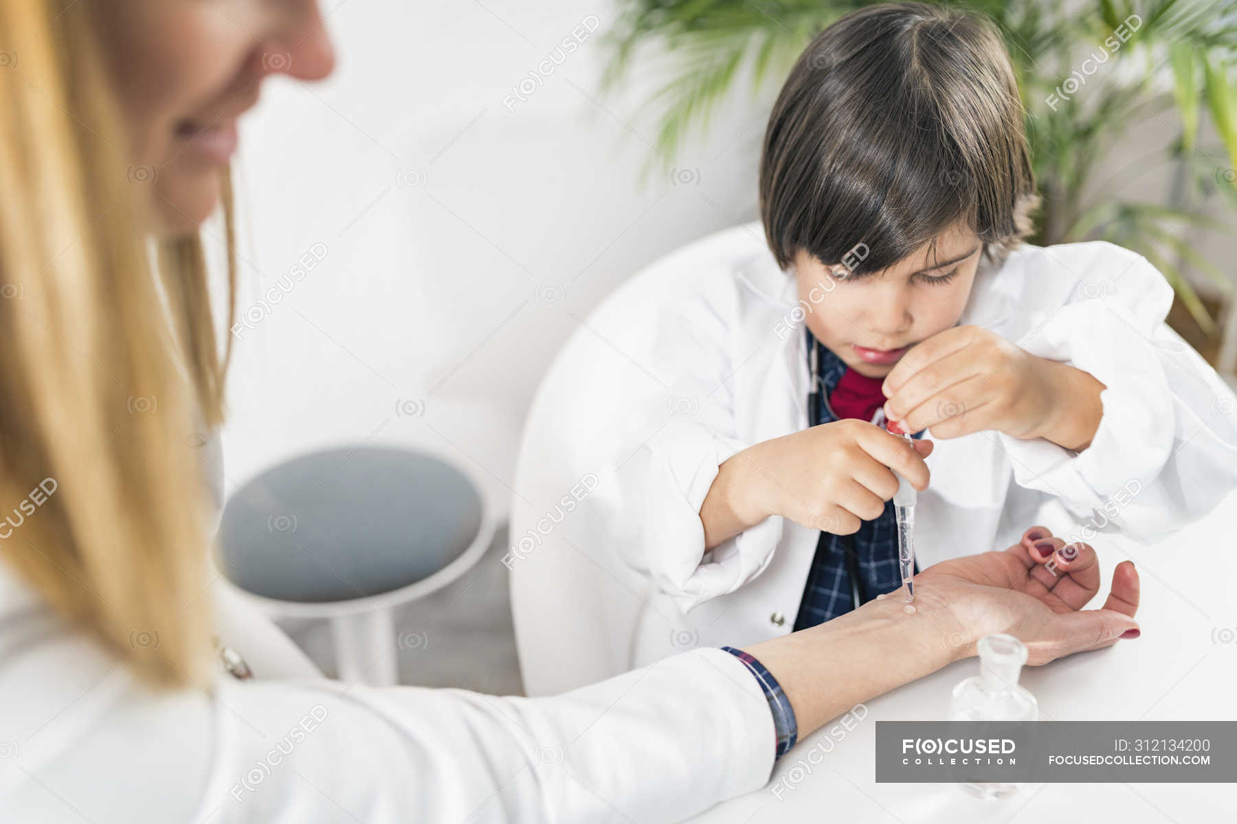 Little boy playing at being doctor in female pediatrician office ...