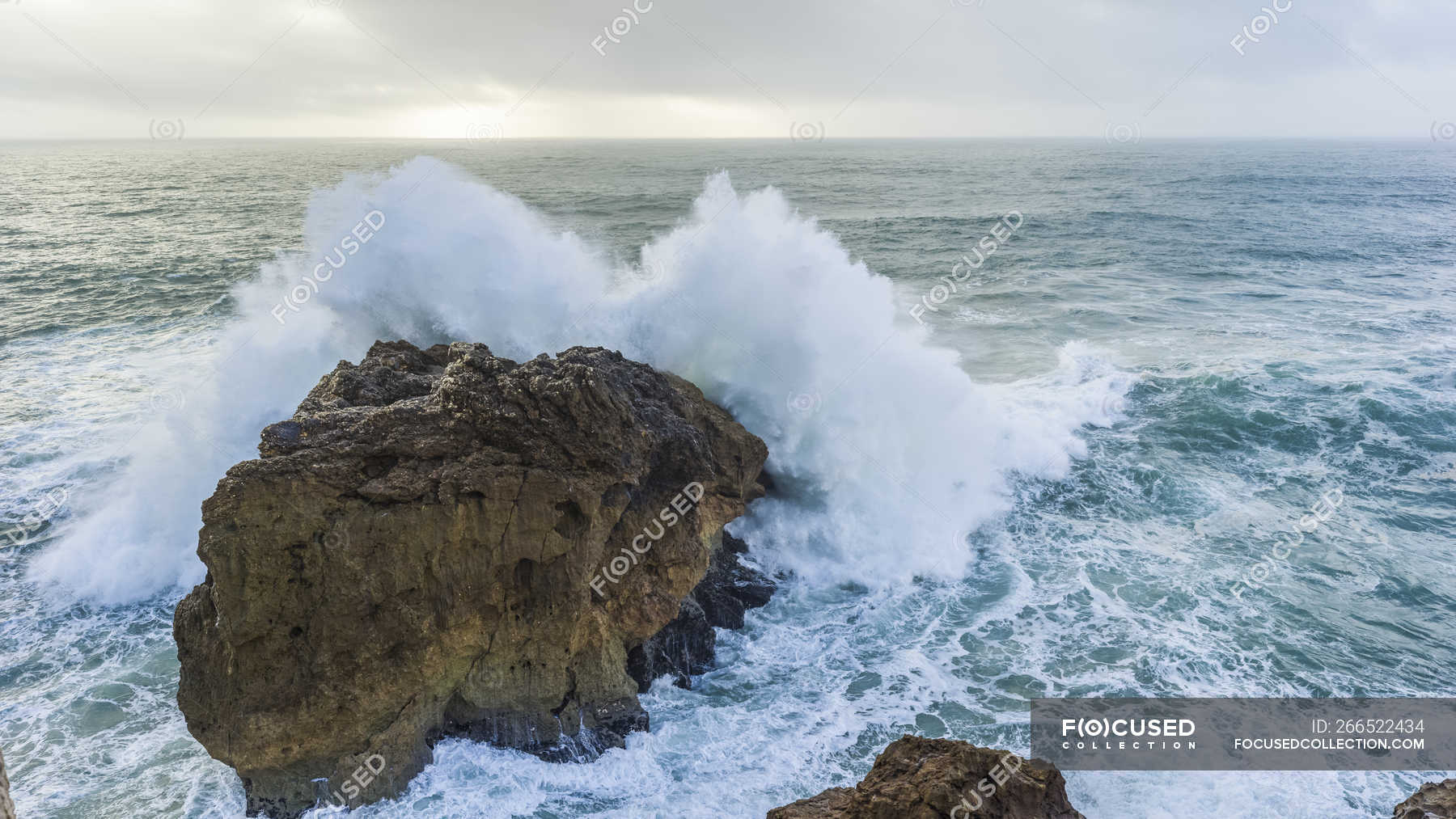 Large wave crashing into a rock along a coast. The biggest waves in the ...