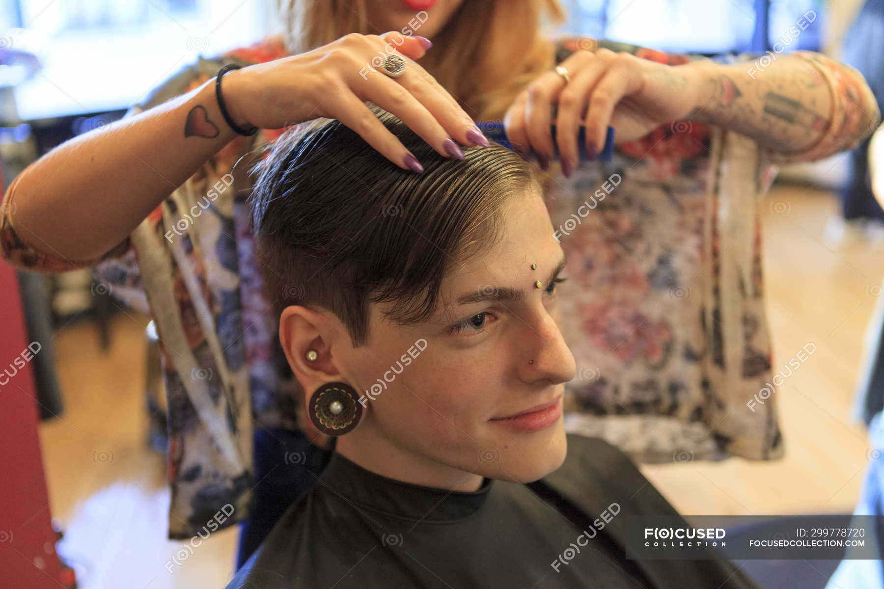 Trendy man with a spinal cord injury at a hair salon getting a hair cut ... Trendy man with a spinal cord injury at a hair salon getting a hair cut ...