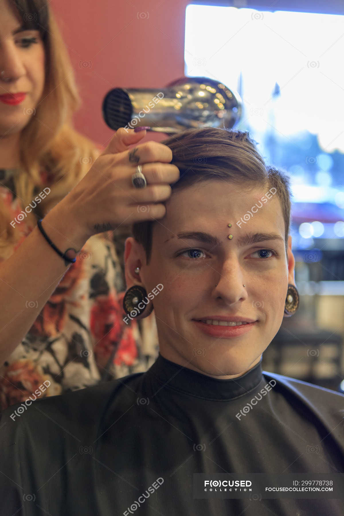 Trendy man with a spinal cord injury at a hair salon getting a hair cut ... Trendy man with a spinal cord injury at a hair salon getting a hair cut ...