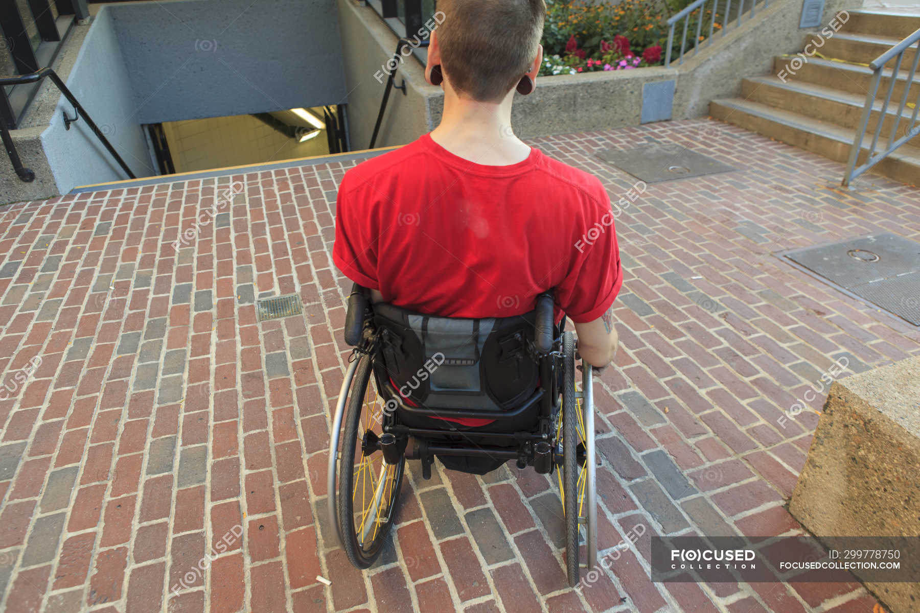 Trendy man with a spinal cord injury in wheelchair planning his access ... Trendy man with a spinal cord injury in wheelchair planning his access ...