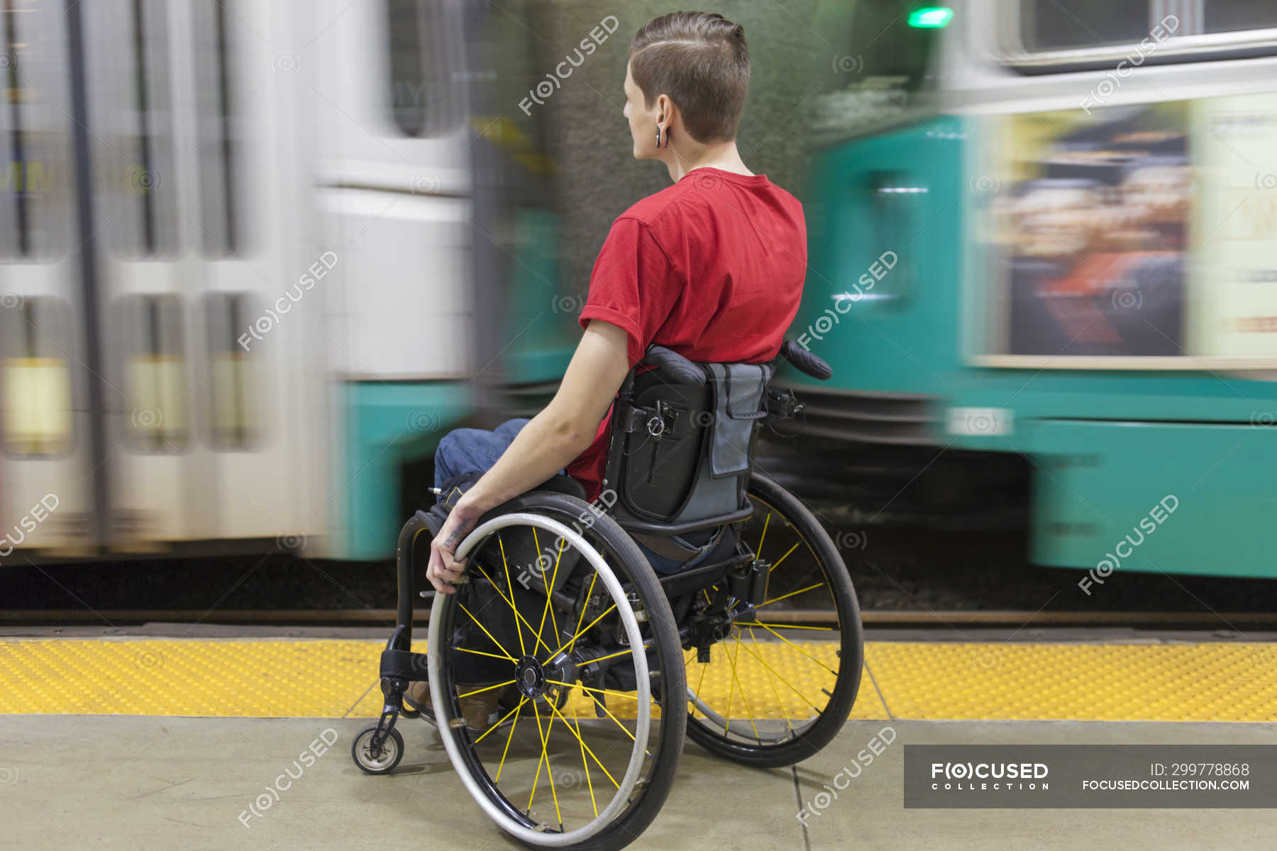 Trendy man with a spinal cord injury in wheelchair waiting for a subway ... Trendy man with a spinal cord injury in wheelchair waiting for a subway ...