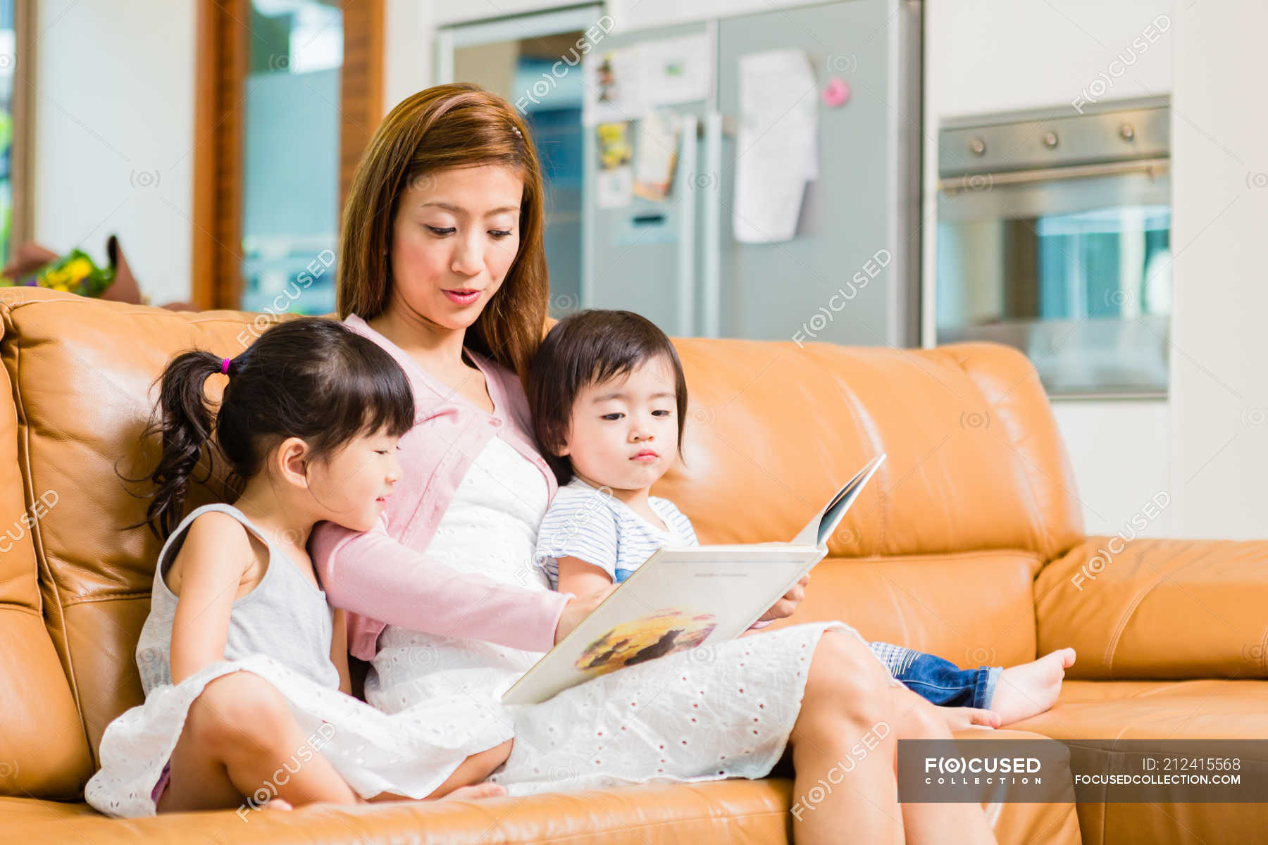 Mother and children reading together at home — daughter, asian - Stock ...