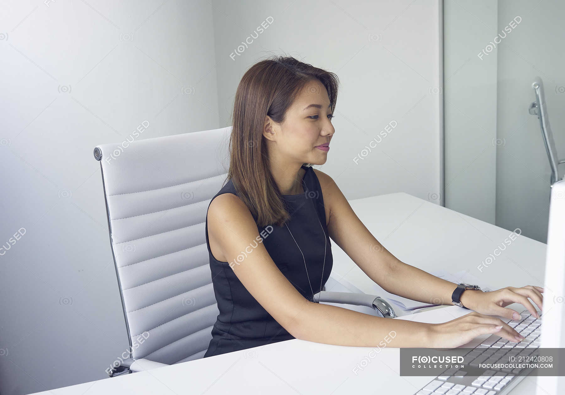 Young asian business woman working with computer at modern office ...