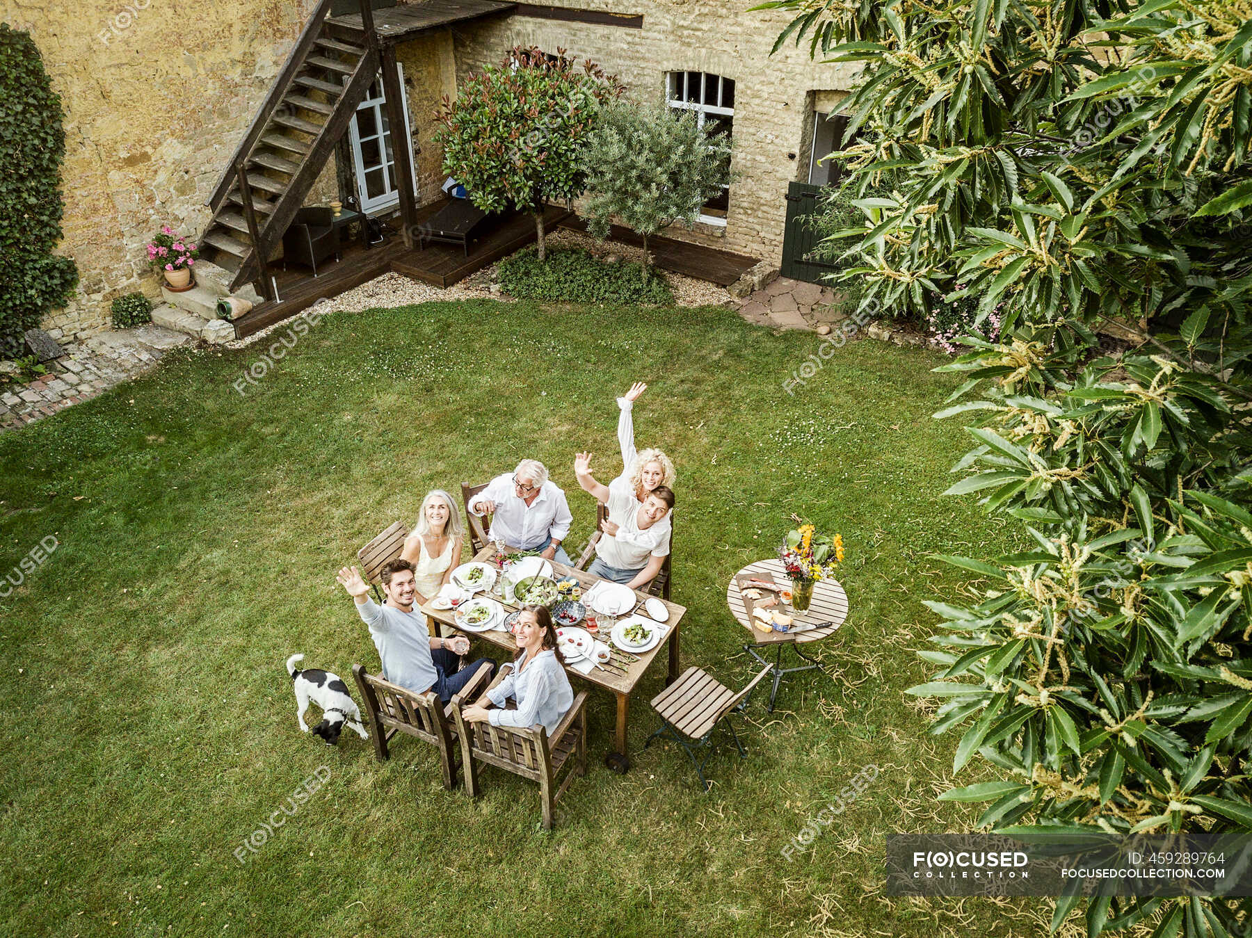 Family Eating Together In The Garden In Summer Aerial View Meadow family-eating-together-in-the-garden-in-summer-aerial-view-meadow