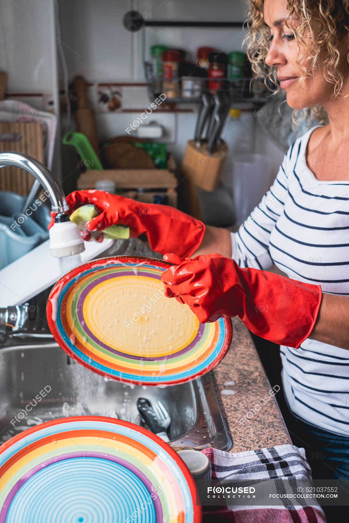 Woman Washing Dishes At Home Kitchen Sink Routine Stock Photo woman-washing-dishes-at-home-kitchen-sink-routine-stock-photo