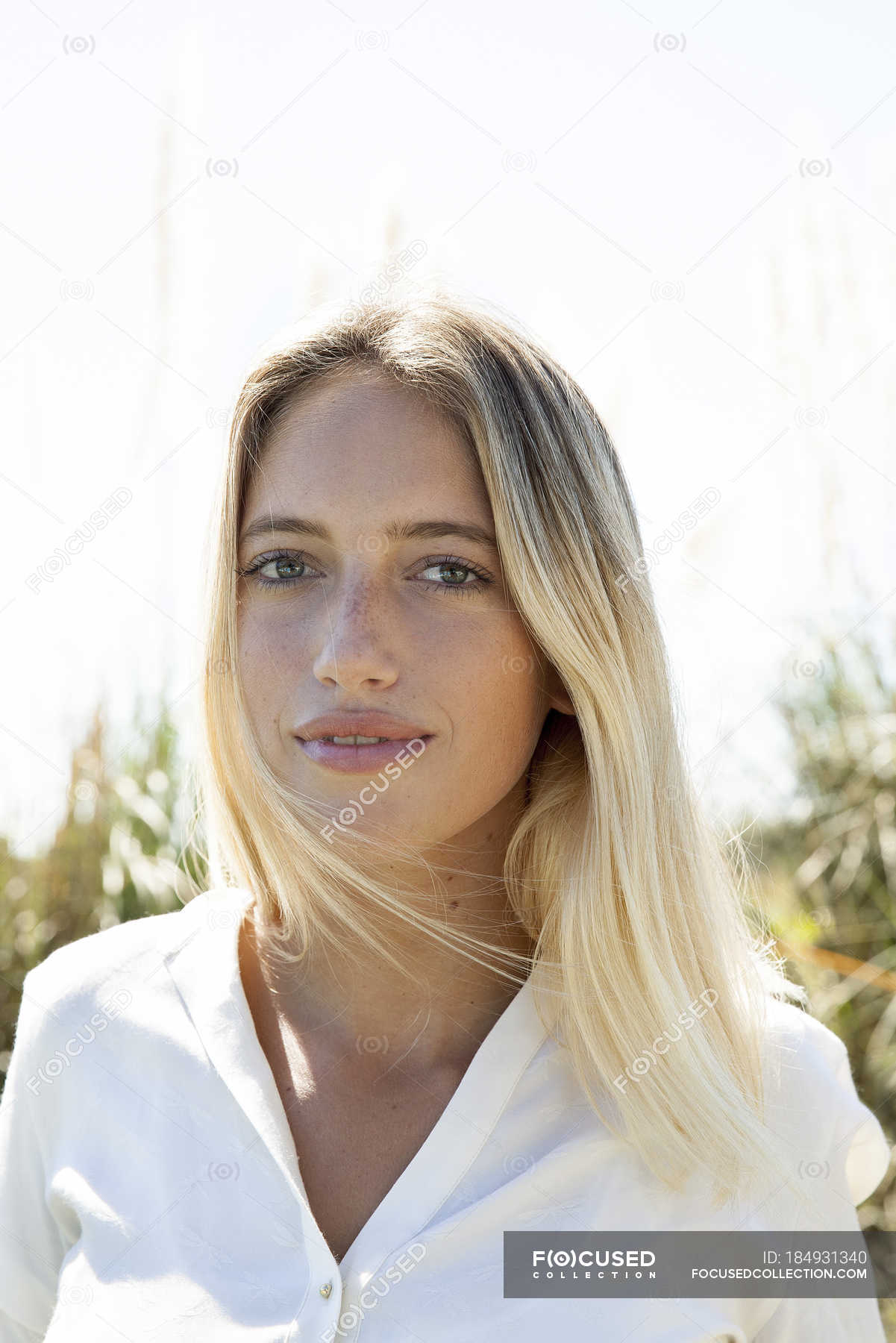 Portrait of young serious woman looking at the camera outdoors — person ... Portrait of young serious woman looking at the camera outdoors — person ...