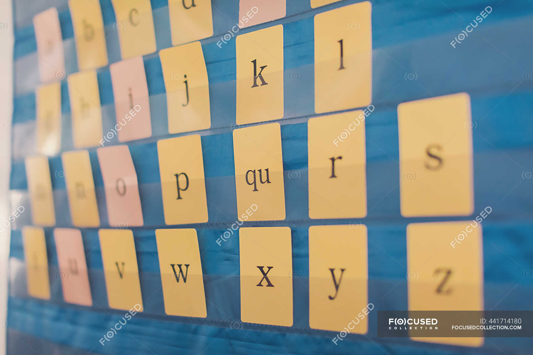 Alphabet cards on blue board on the wall of Elementary School. — papers ...