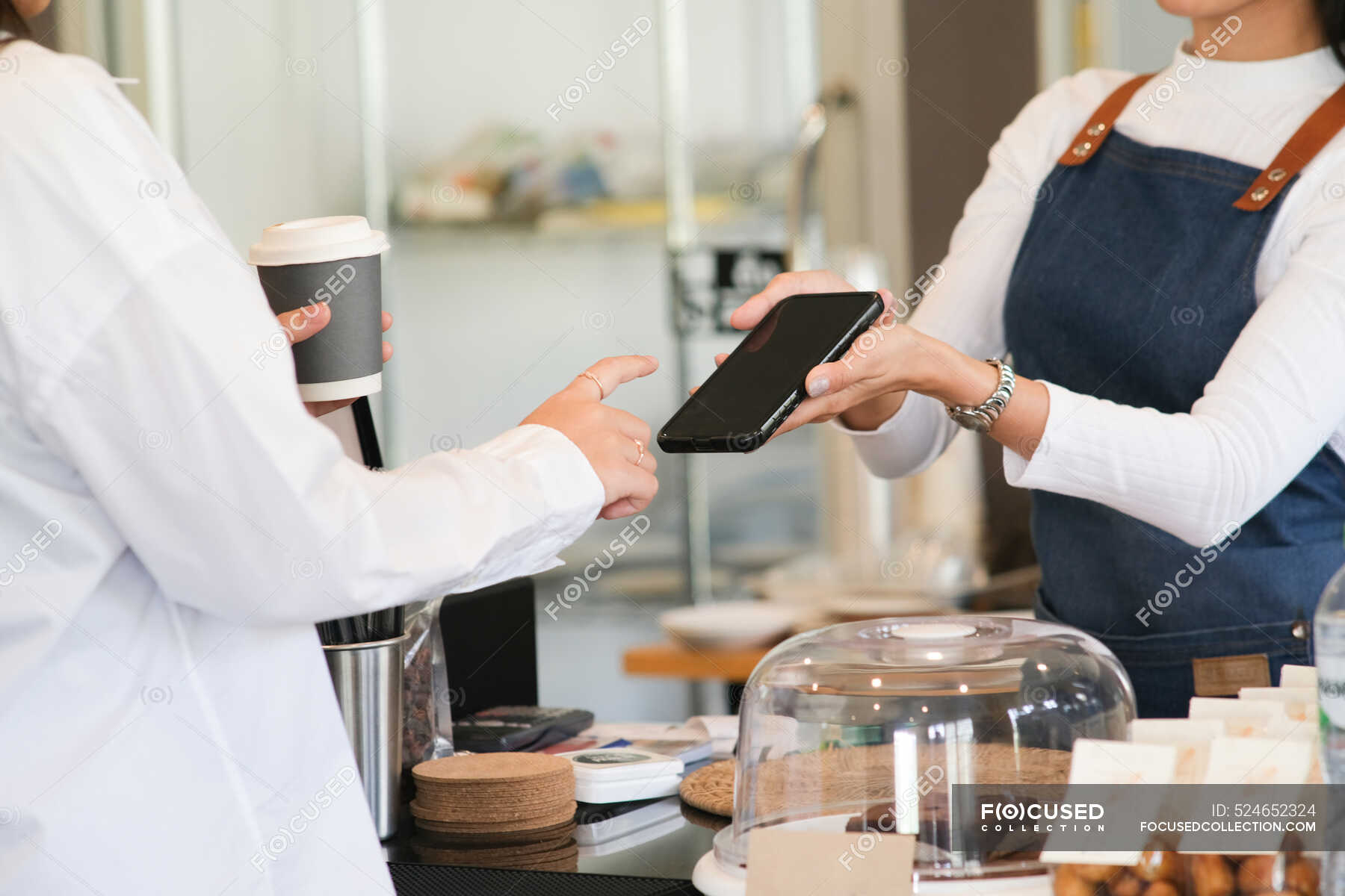 Customer making payment using NFS technology at coffee cafe. Small ... Customer making payment using NFS technology at coffee cafe. Small ...