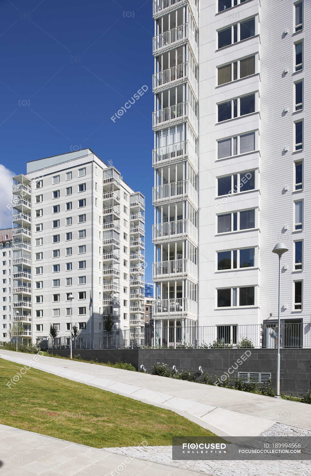 Front view of white buildings in Eriksberg, Sweden — grass, buildings ...