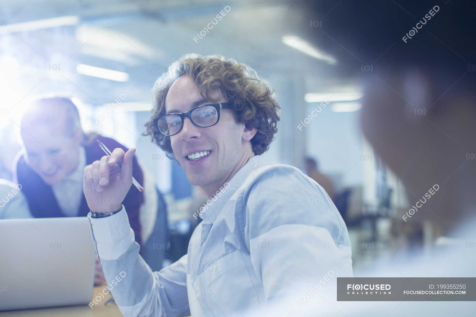 Happy young businessman smiling in office — pride, brainstorming ...