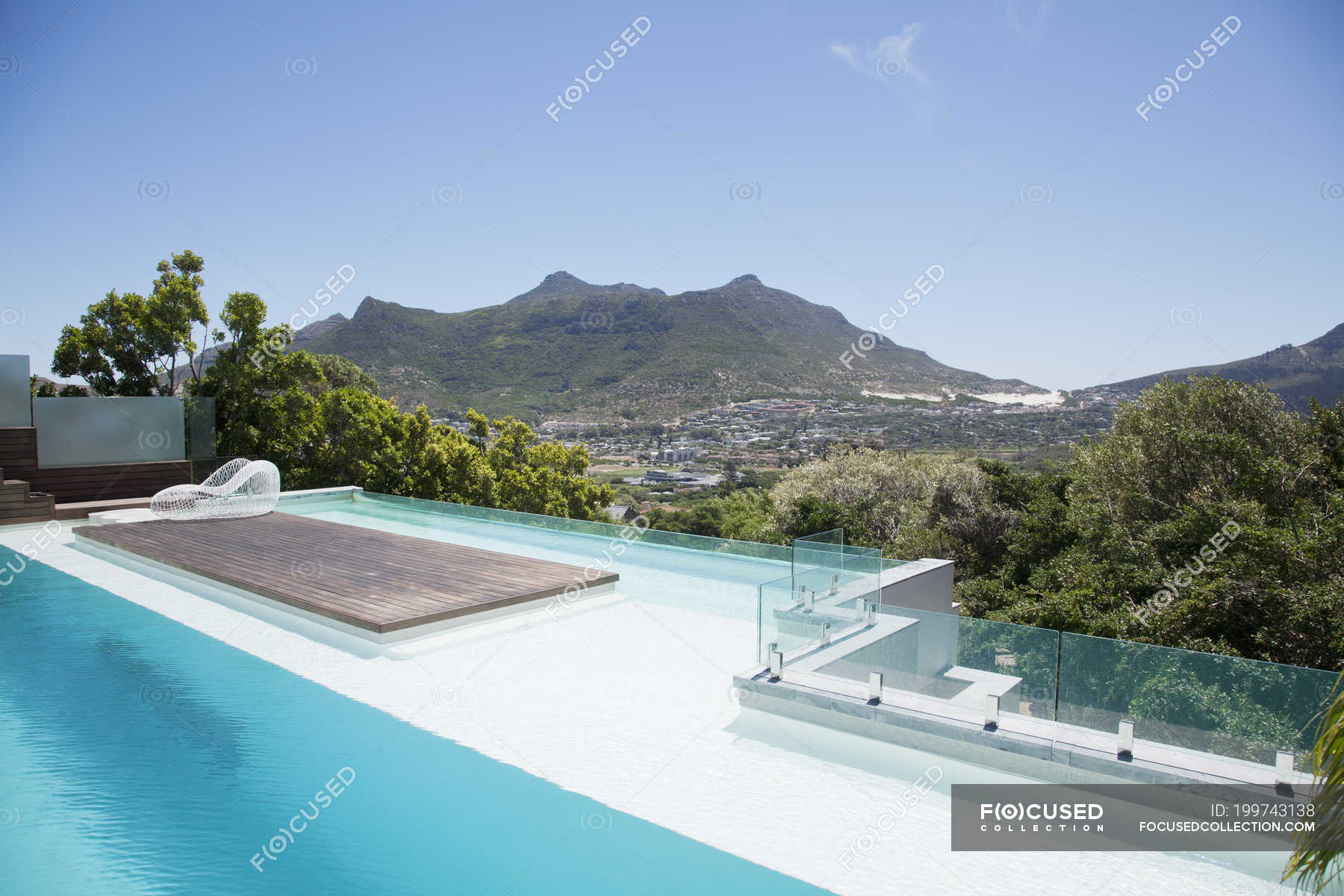 Scenic view of luxury swimming pool and mountains — comfortable ...