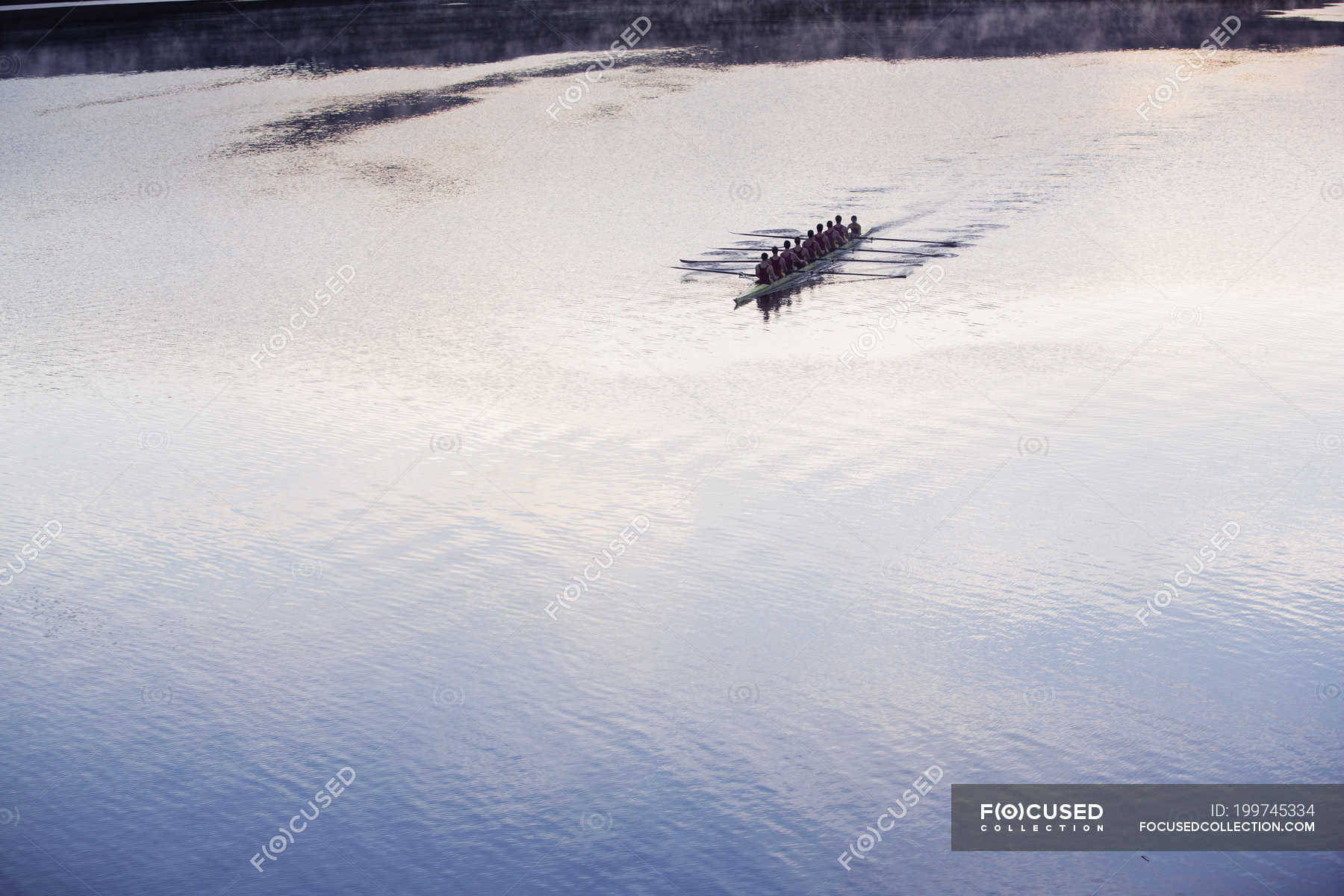 Rowing crew rowing scull on lake in distance — Sports Clothing, Sport ... Rowing crew rowing scull on lake in distance — Sports Clothing, Sport ...