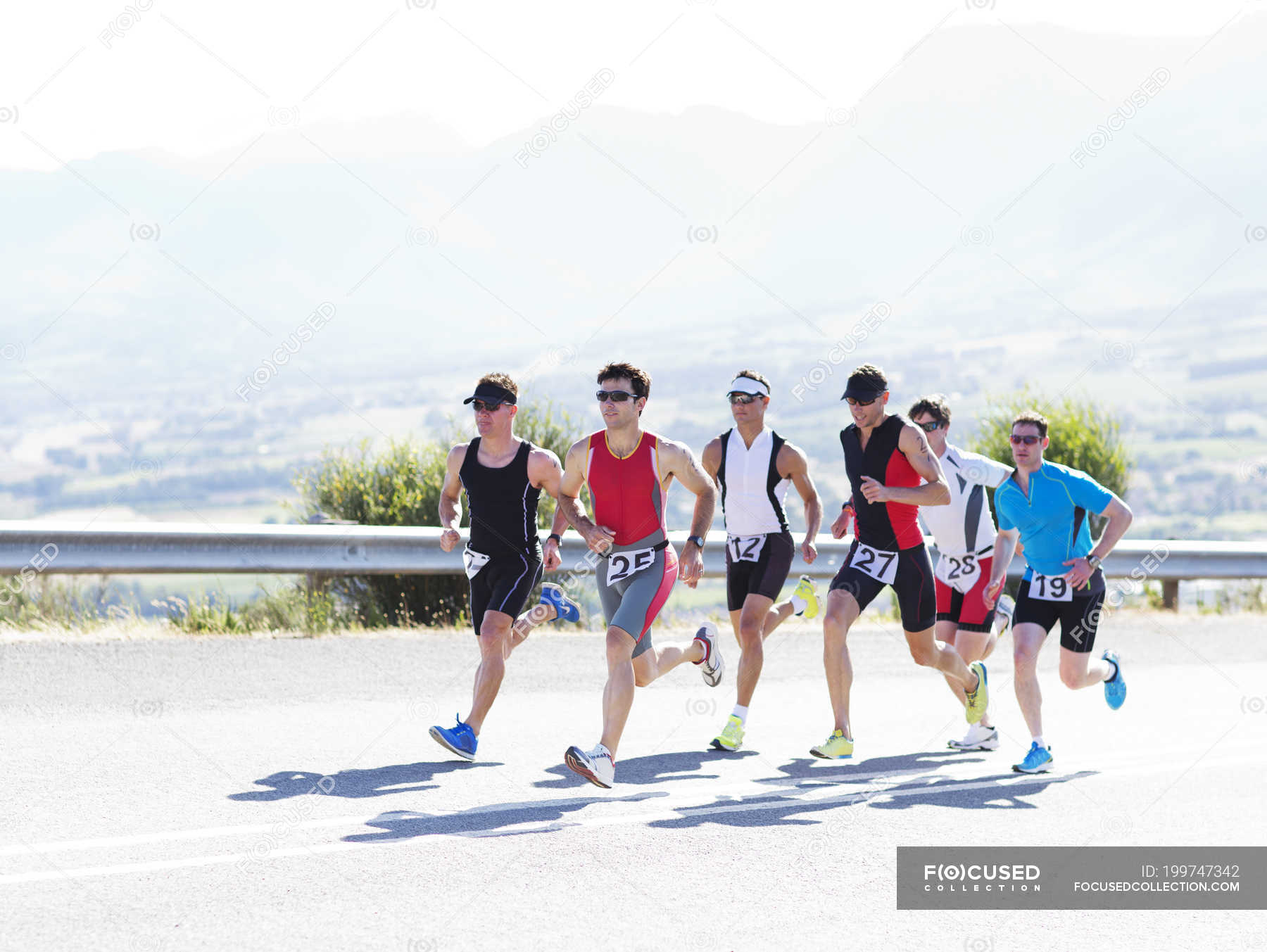 Runners in race on rural road — determination, fit - Stock Photo ...