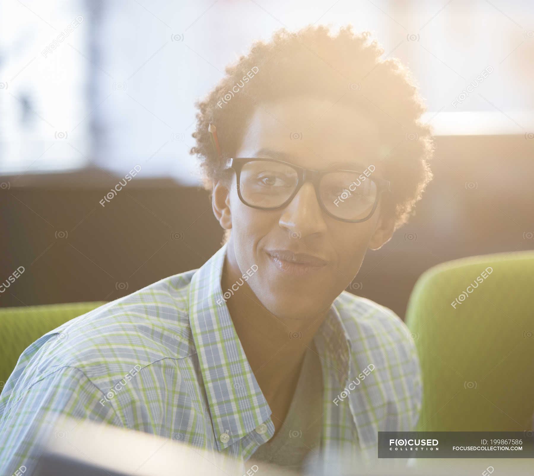 Black businessman smiling in modern office — people, sitting - Stock ...