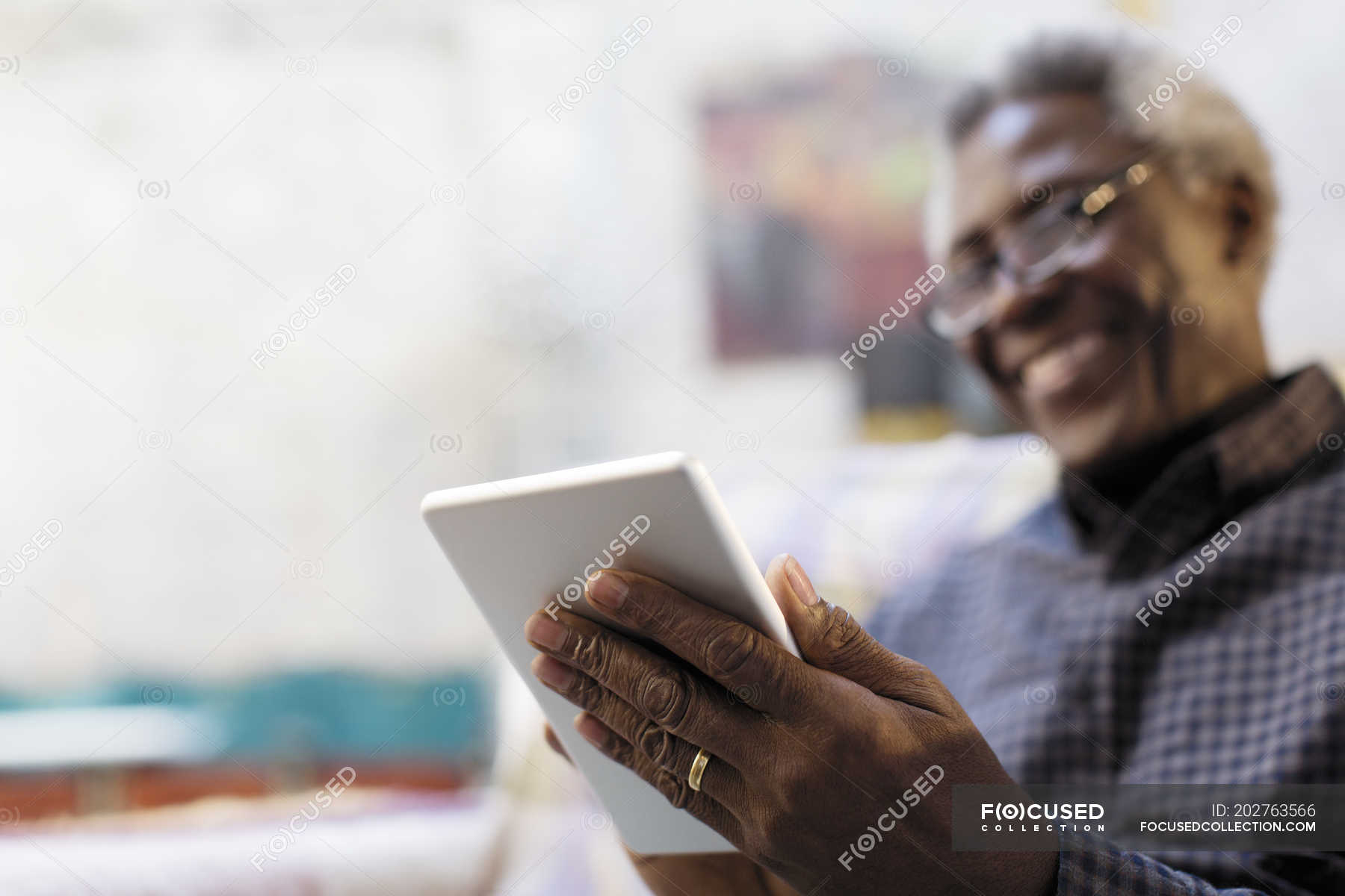 Smiling senior man using digital tablet — copy space, Portability ...