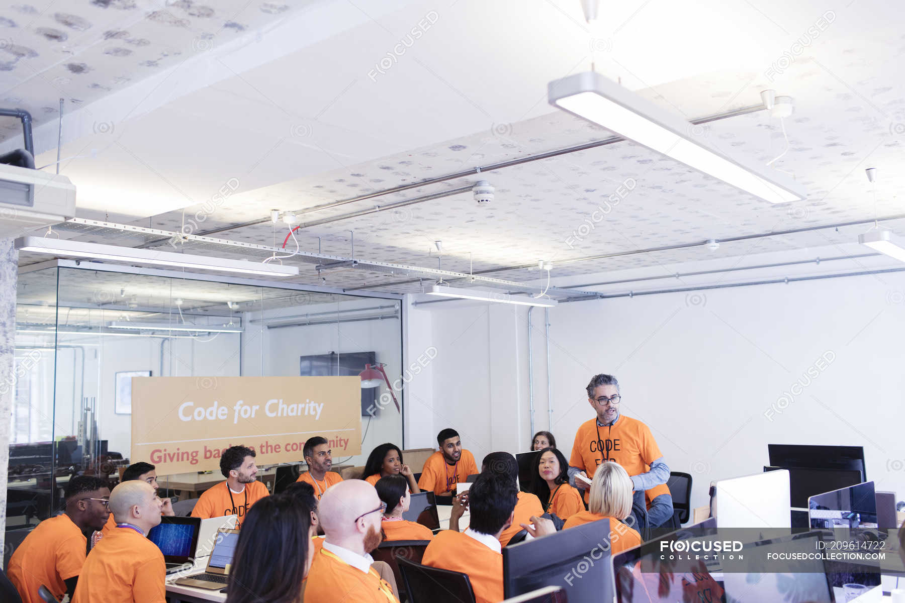 Hackers coding for charity at hackathon — crowdfunding, event - Stock ...