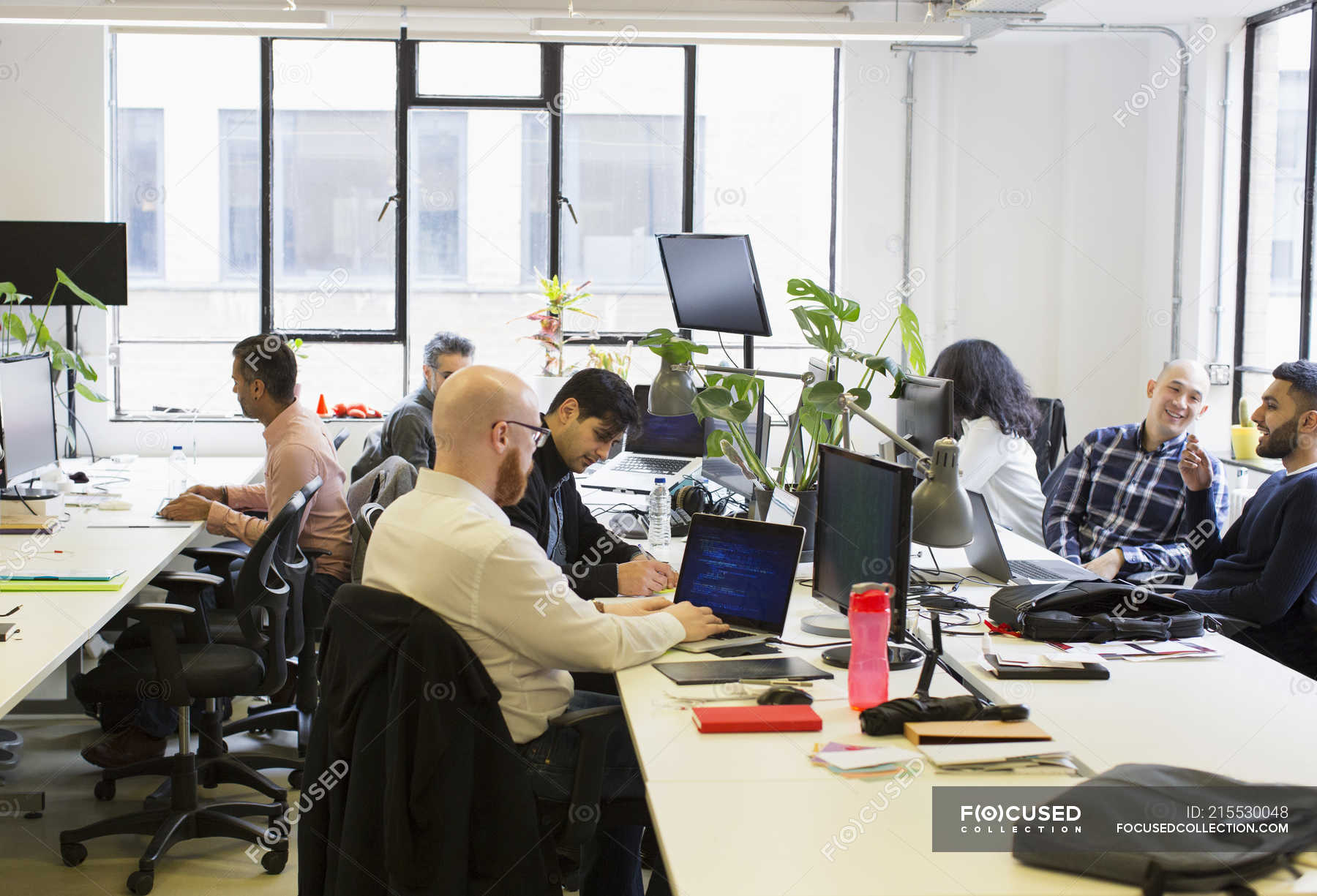 Computer programmers working in open plan office — multiracial, success ... Computer programmers working in open plan office — multiracial, success ...