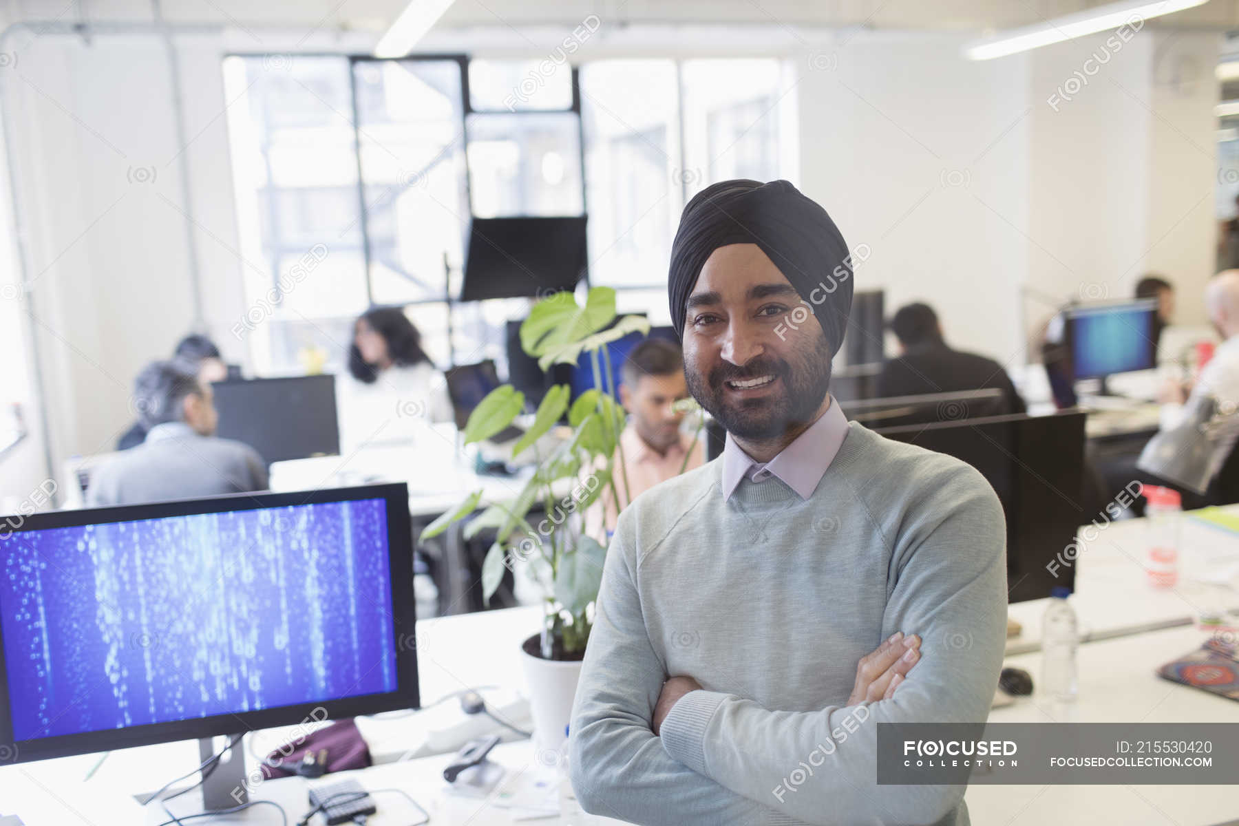 Portrait smiling, confident Indian computer programmer in turban in ...