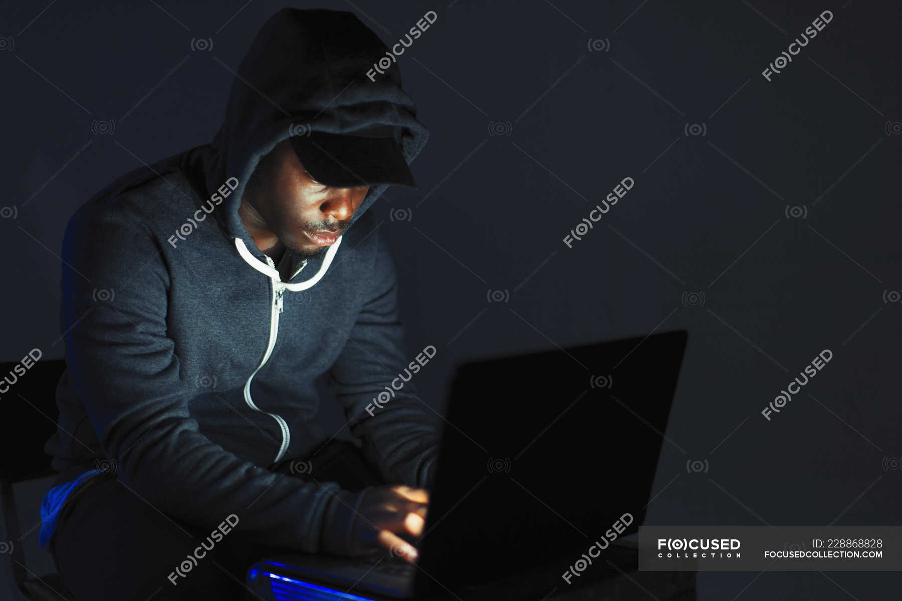 Teenage boy in hoody leaning over laptop — Computer Hacker, using ... Teenage boy in hoody leaning over laptop — Computer Hacker, using ...
