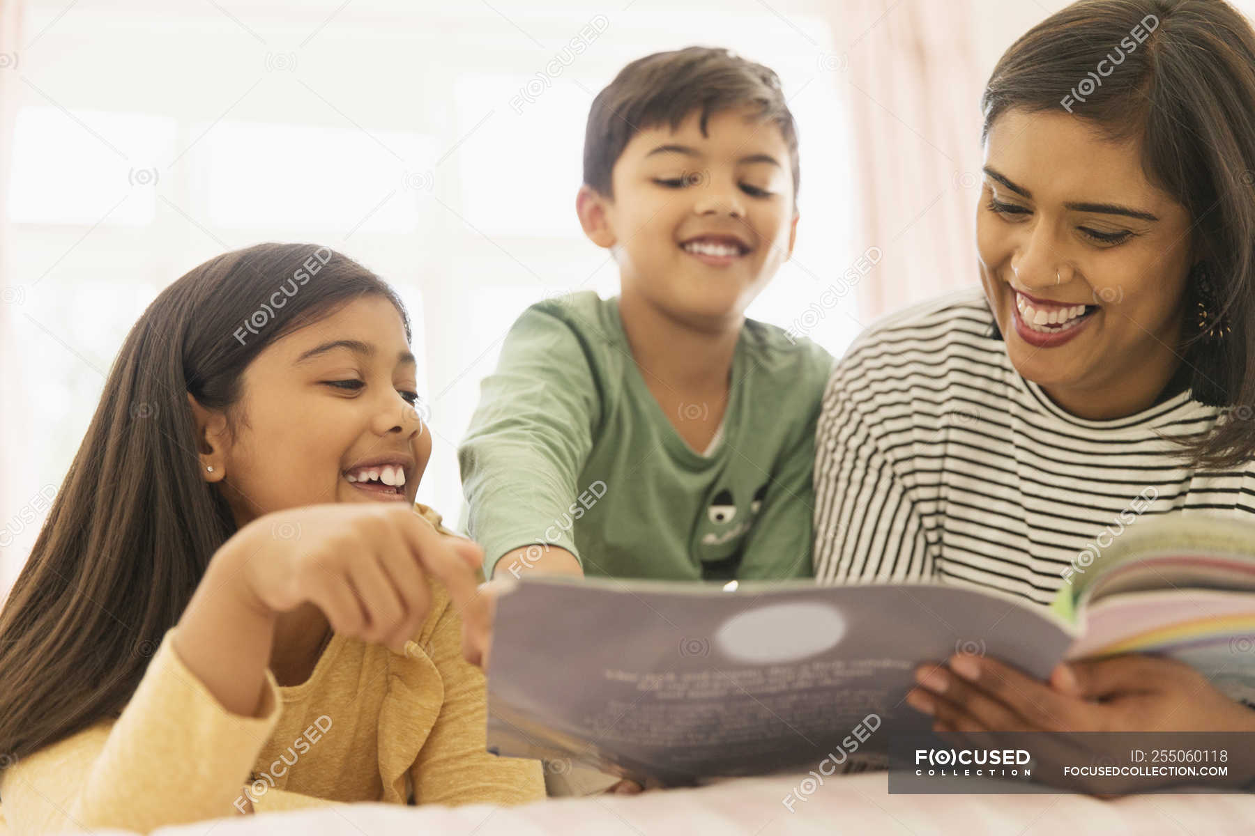Mother and children reading book — daughter, sister - Stock Photo ...