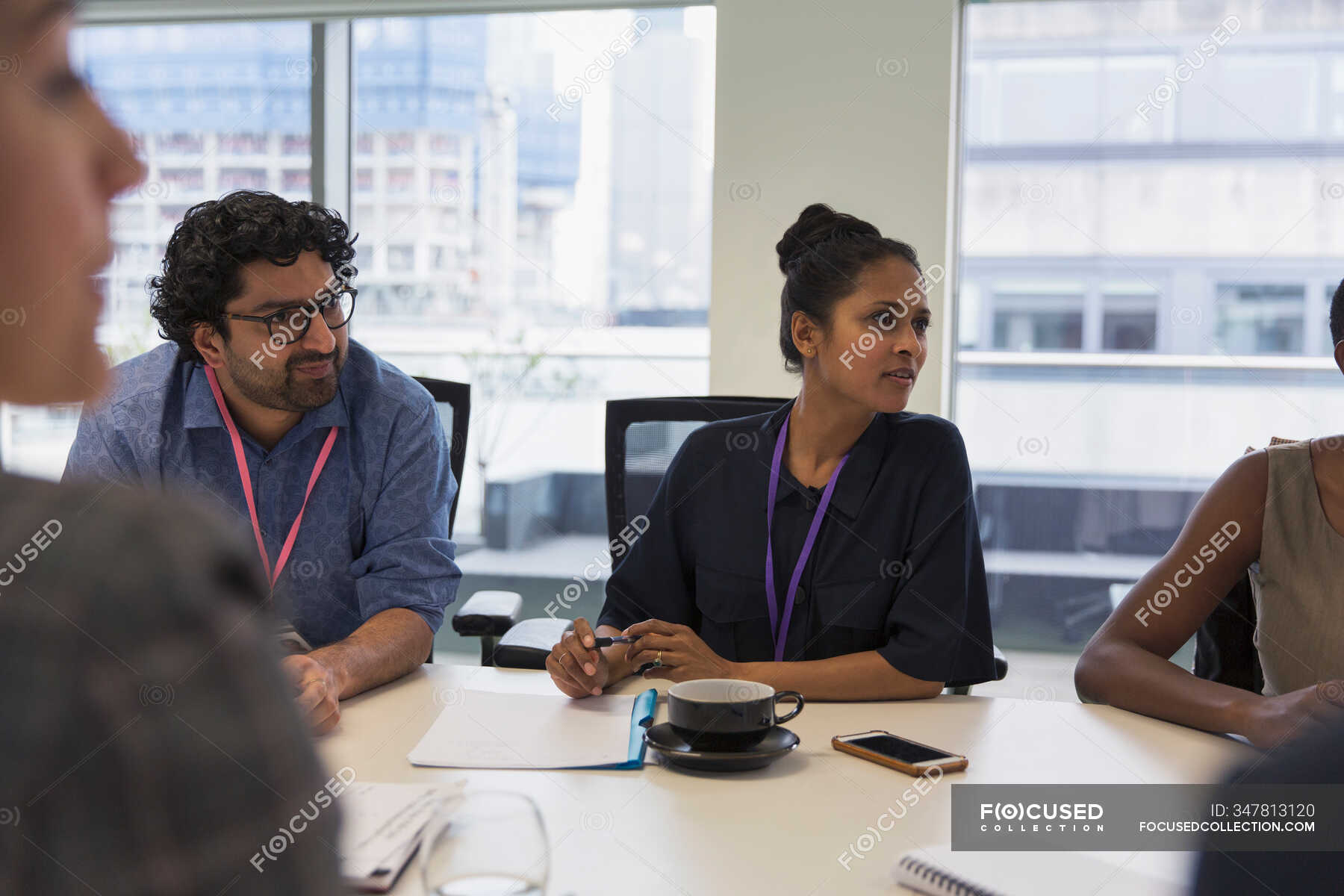 Attentive businesswoman listening in conference room meeting — plan ... Attentive businesswoman listening in conference room meeting — plan ...