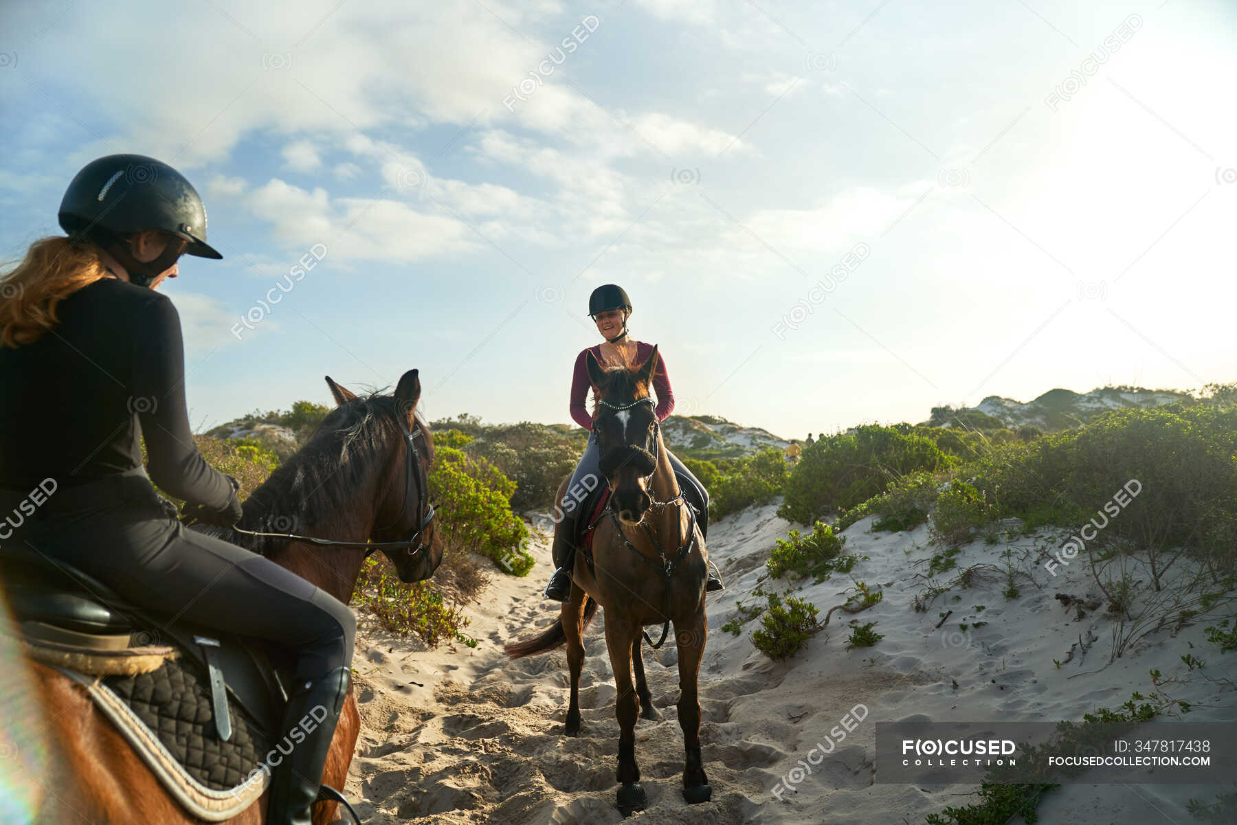 Young women horseback riding on sunny beach — lifestyle, helmet - Stock ... Young women horseback riding on sunny beach — lifestyle, helmet - Stock ...