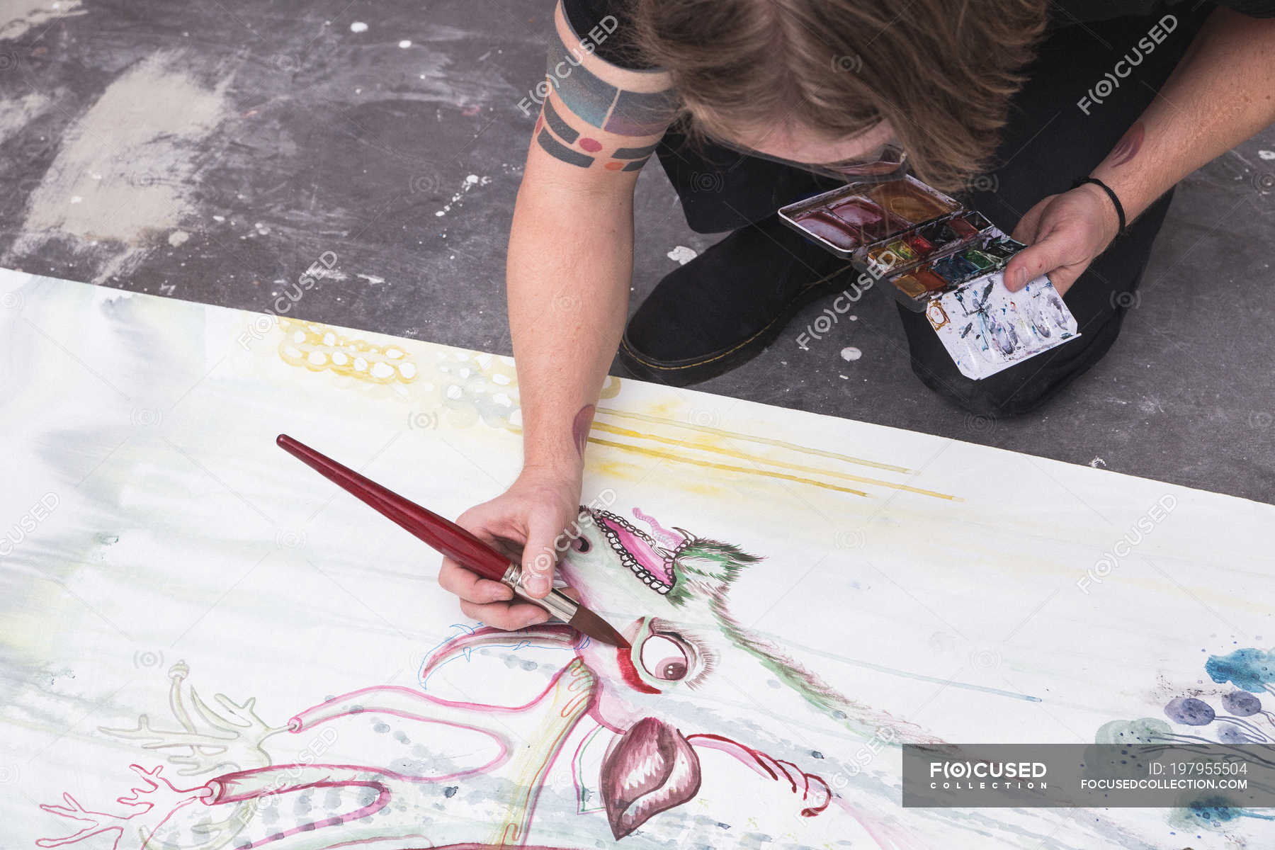 Creative male artist working in his workshop with brush in hand ...