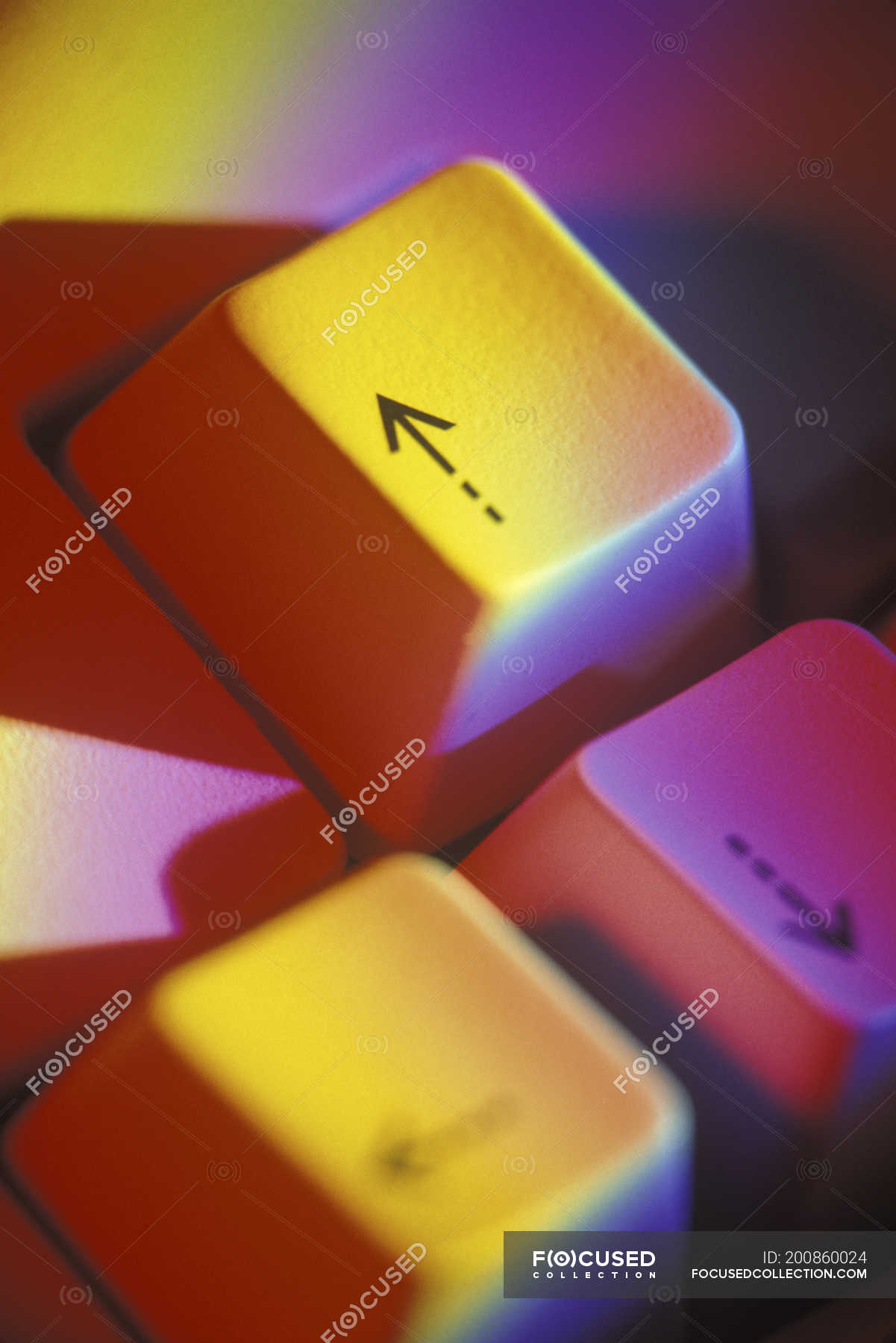 Keyboard buttons with arrows in yellow light — close up, equipment ...