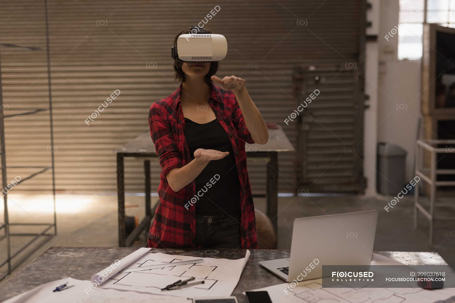 Female engineer using virtual reality headset in workshop. — technology ...