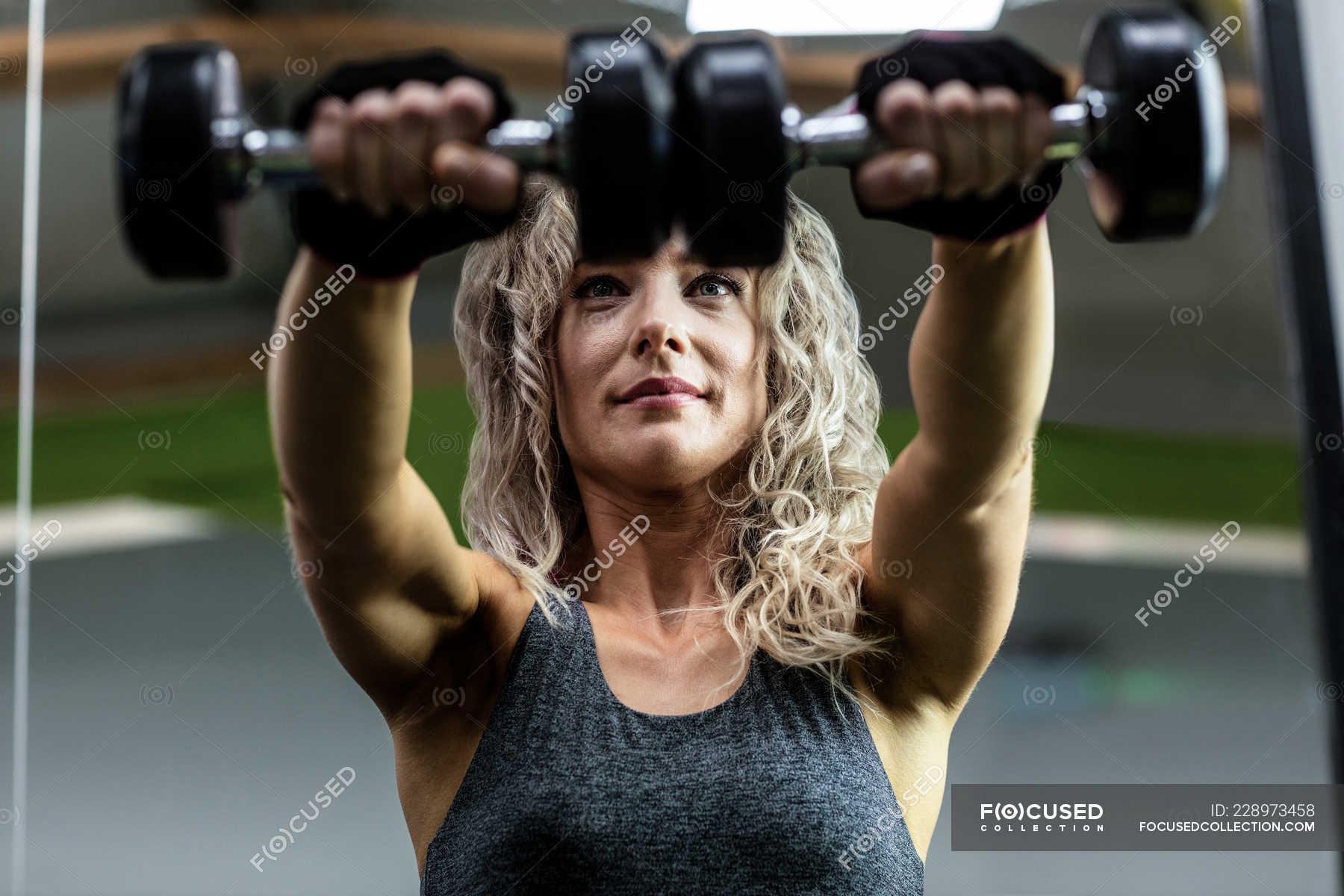 Beautiful Woman Lifting Dumbbells At Gym — Exercising Strong Stock
