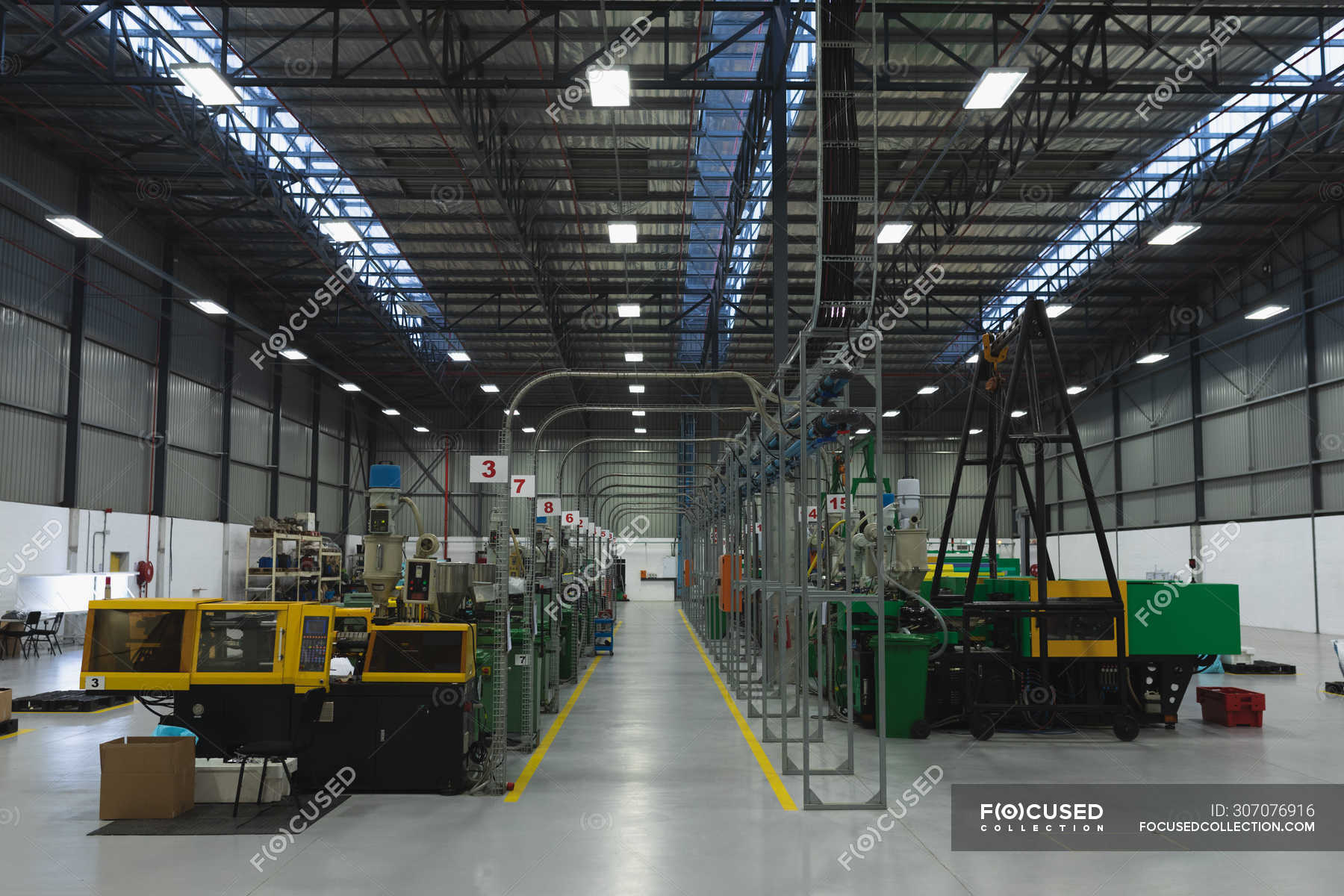 Front view of two rows of processing equipment in a warehouse at a ...