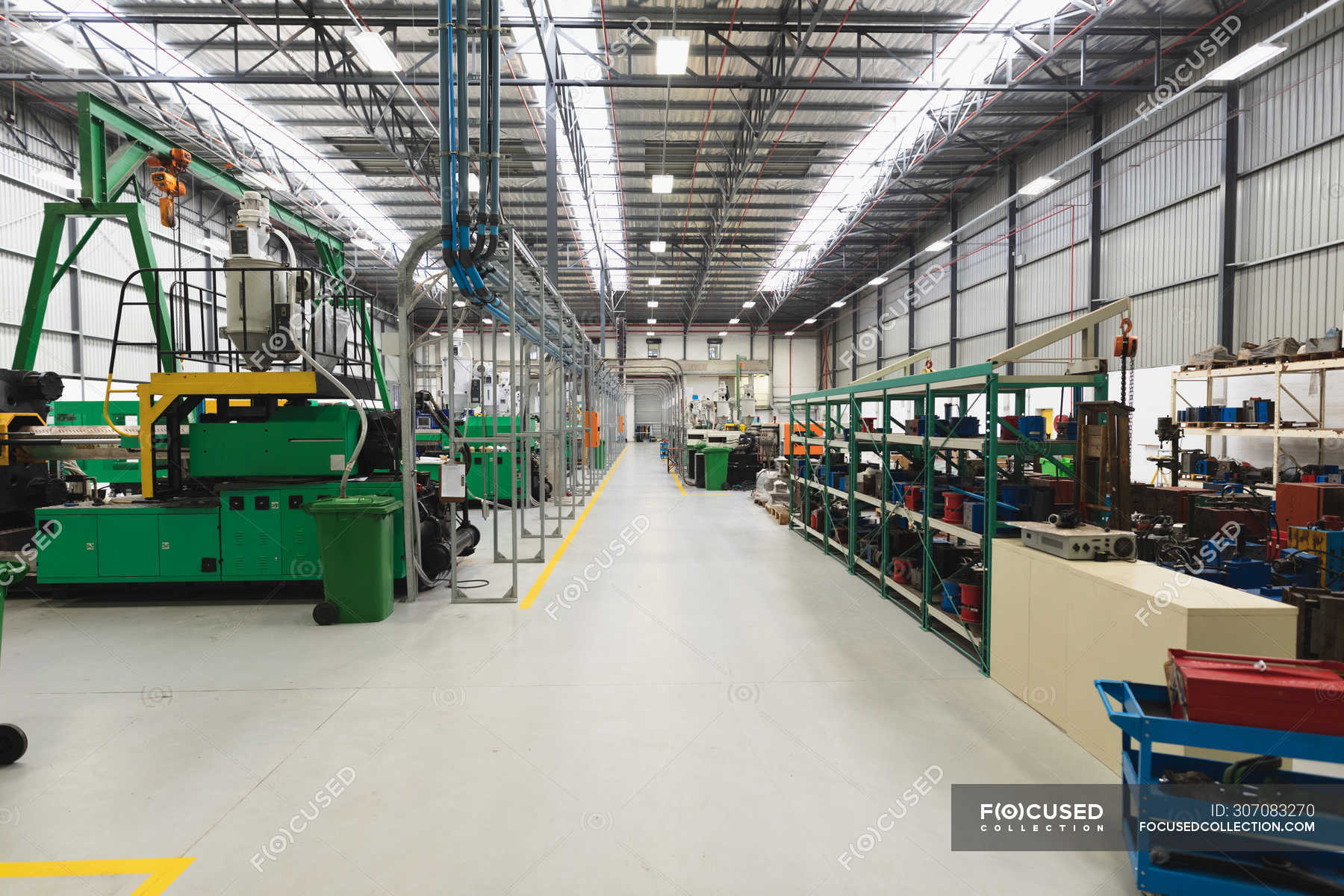 Front View Of A Row Of Processing Equipment And A Storage Area In A Warehouse At A Processing