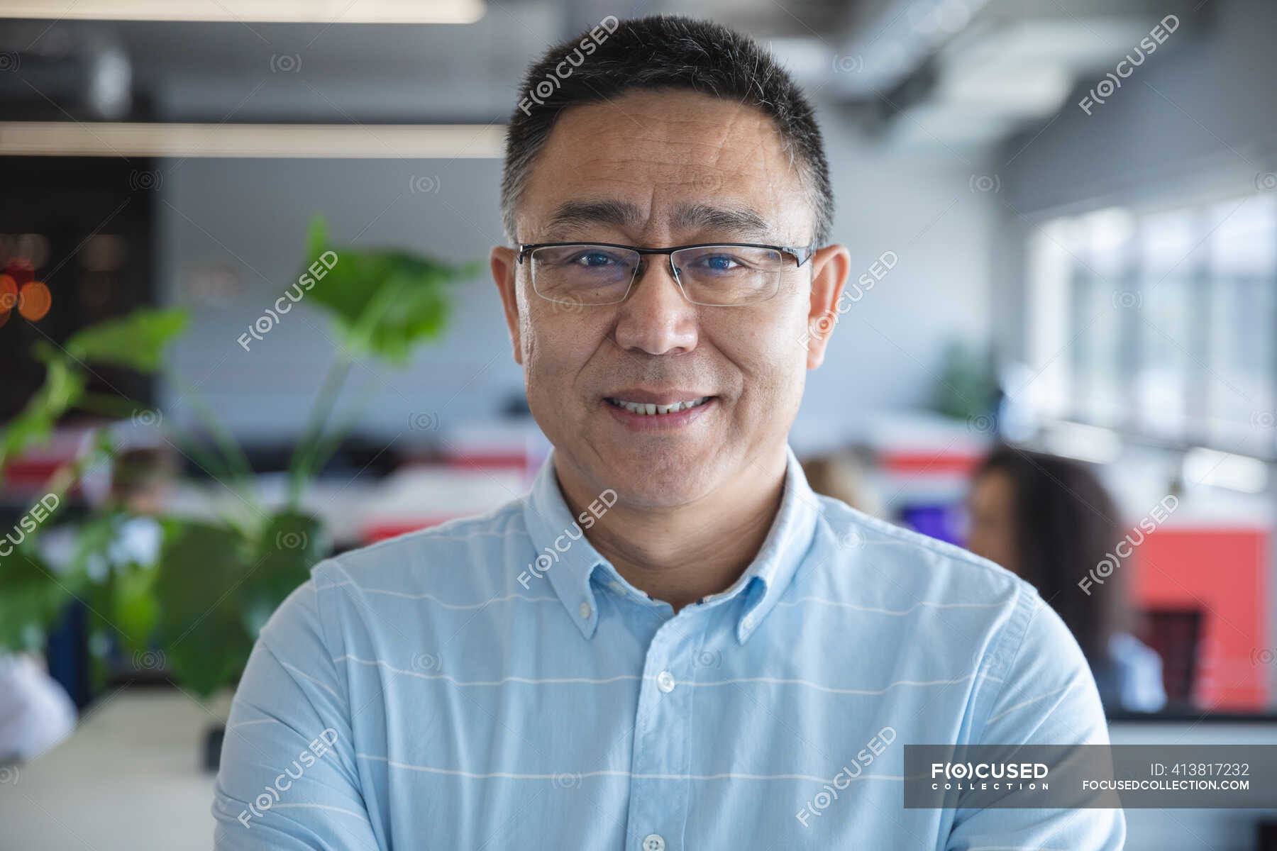 Portrait of smart casually dressed Asian male business creative wearing ...