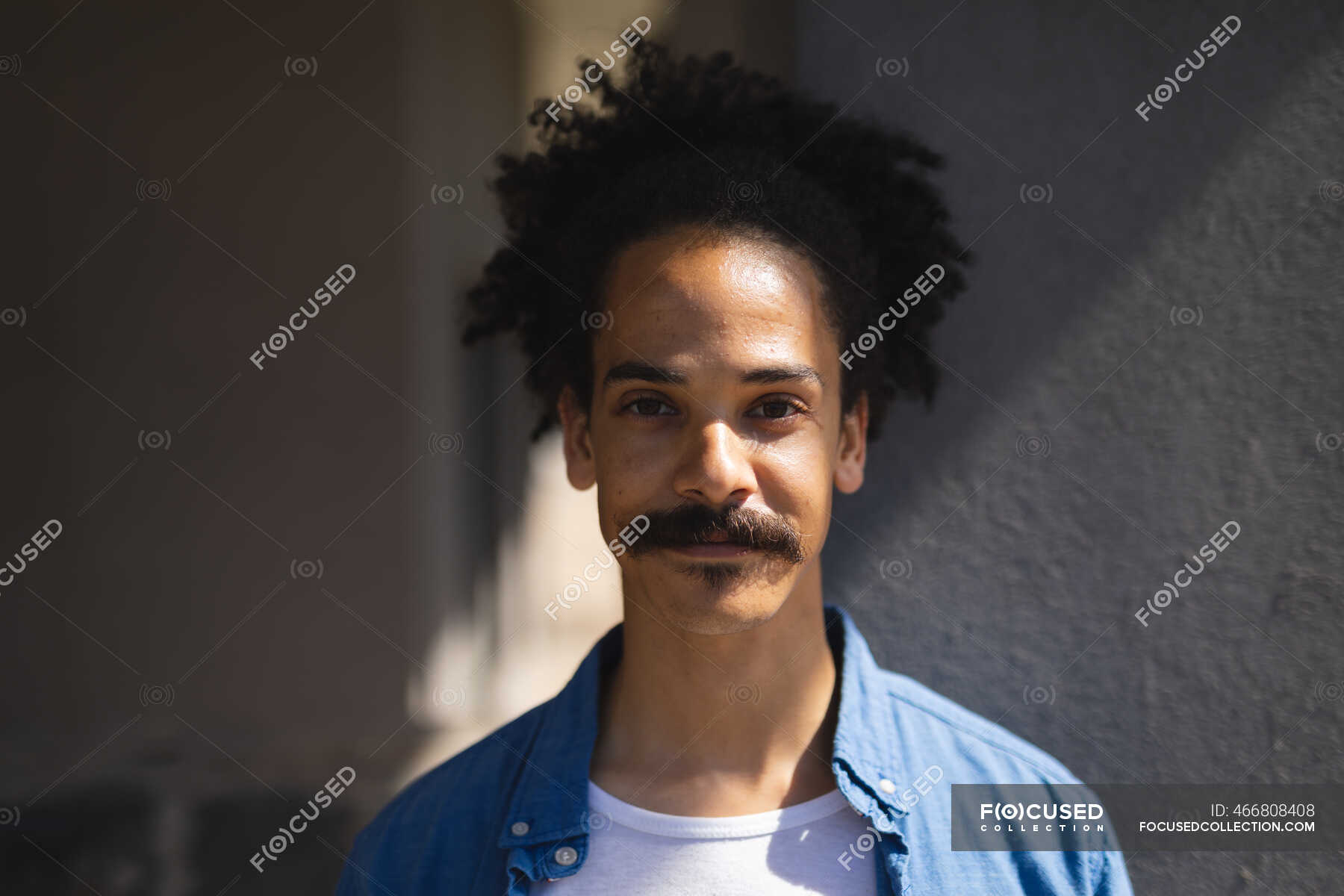 Portrait of mixed race male with moustache looking to camera. green ... Portrait of mixed race male with moustache looking to camera. green ...