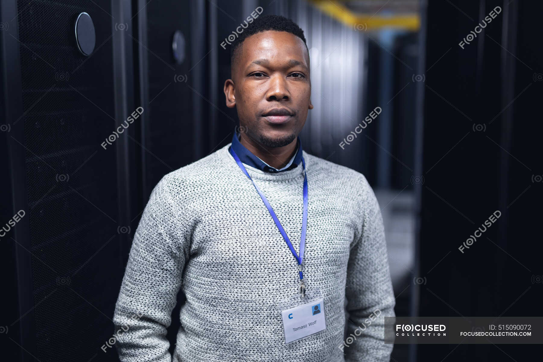Portrait of african american male computer technician working in server ...