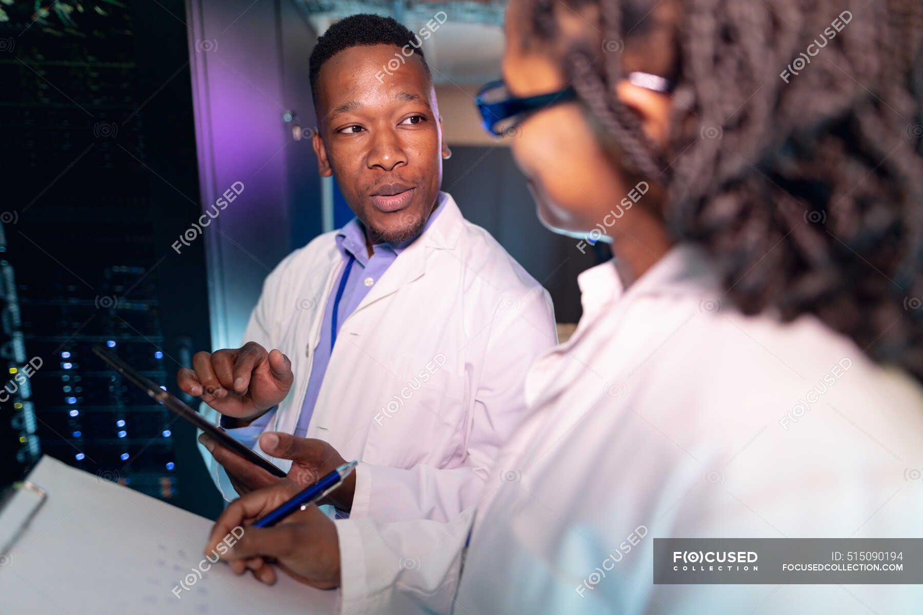 African american computer technicians using tablet working in server ...