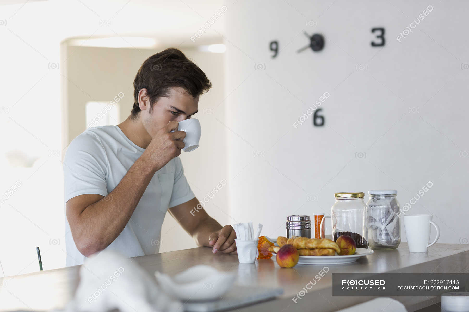 Close-up of young man drinking coffee at home — warm drink, lifestyle ... Close-up of young man drinking coffee at home — warm drink, lifestyle ...