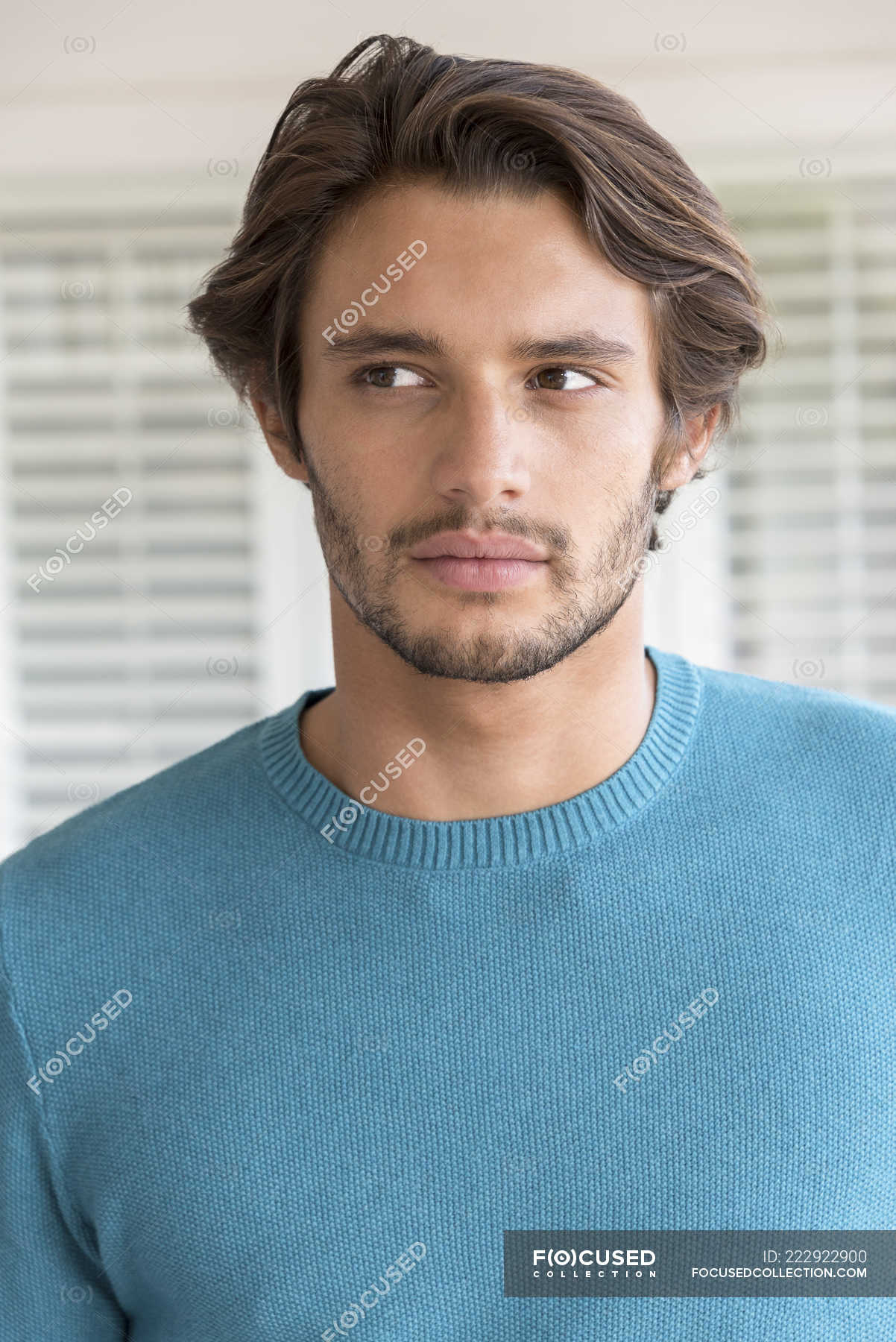 Portrait of thoughtful young man in blue pullover looking away — young ... Portrait of thoughtful young man in blue pullover looking away — young ...