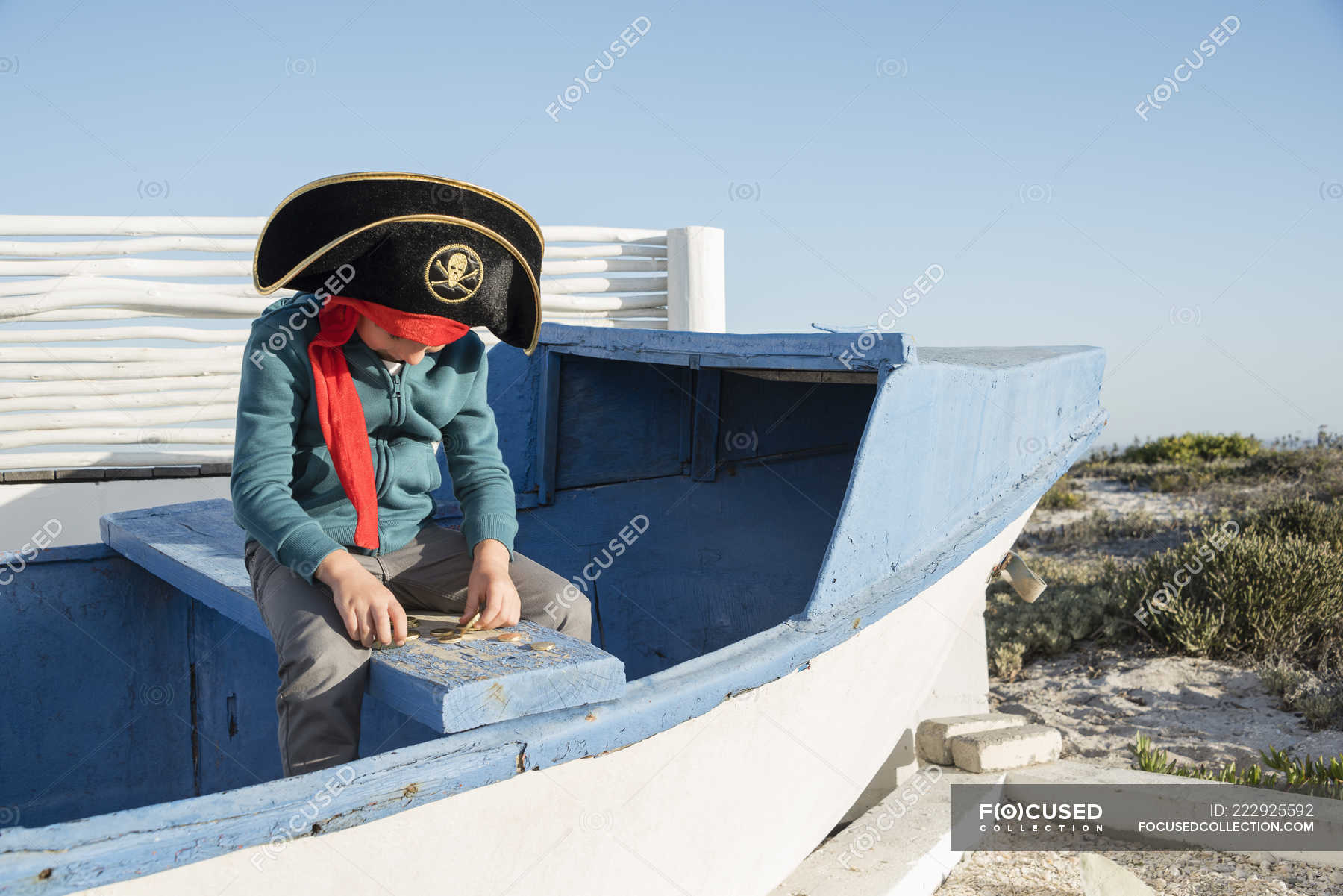 Pirate little boy counting coins on wooden boat outdoors — disguise ...