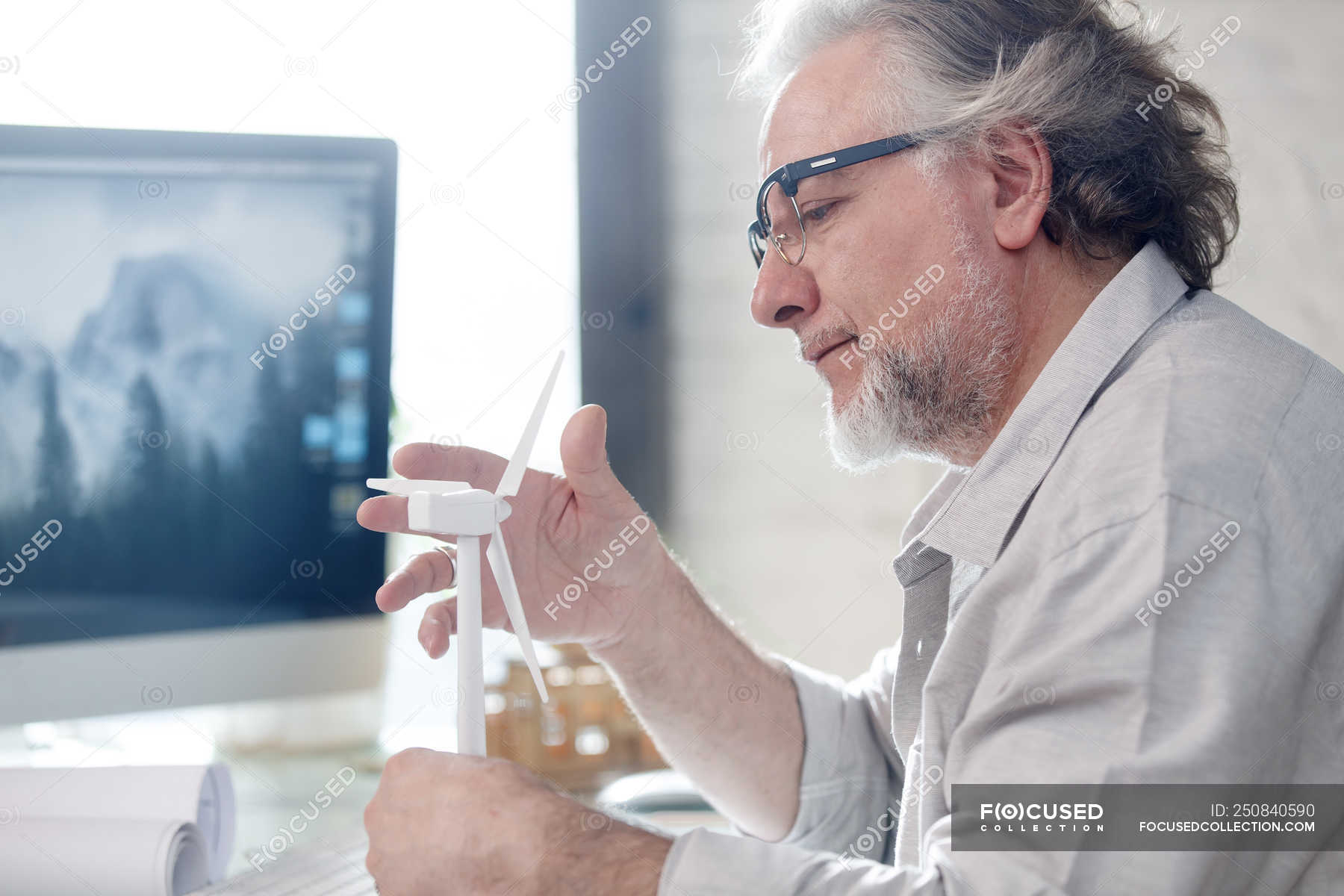 Side view of serious professional mature architect in eyeglasses ...
