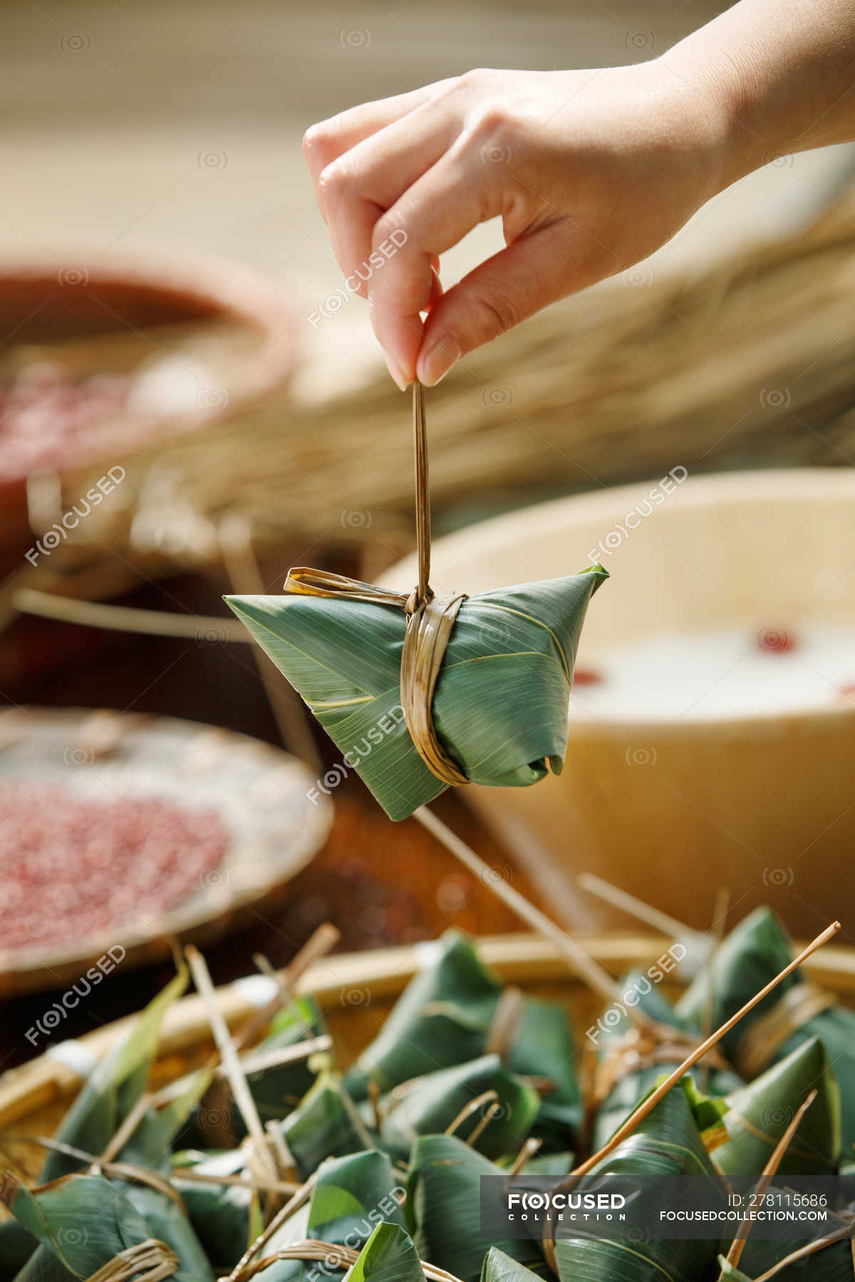 Partial view of woman cooking traditional chinese dish zongzi ... Partial view of woman cooking traditional chinese dish zongzi ...