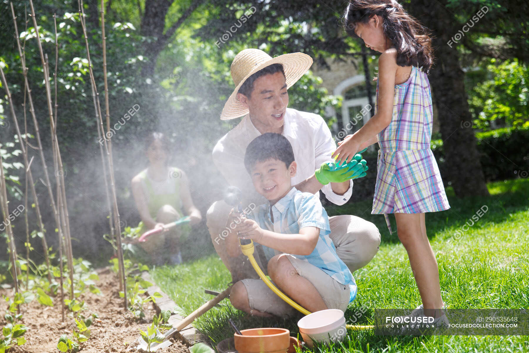 Happy family in the garden vegetables — plant, togetherness - Stock ...